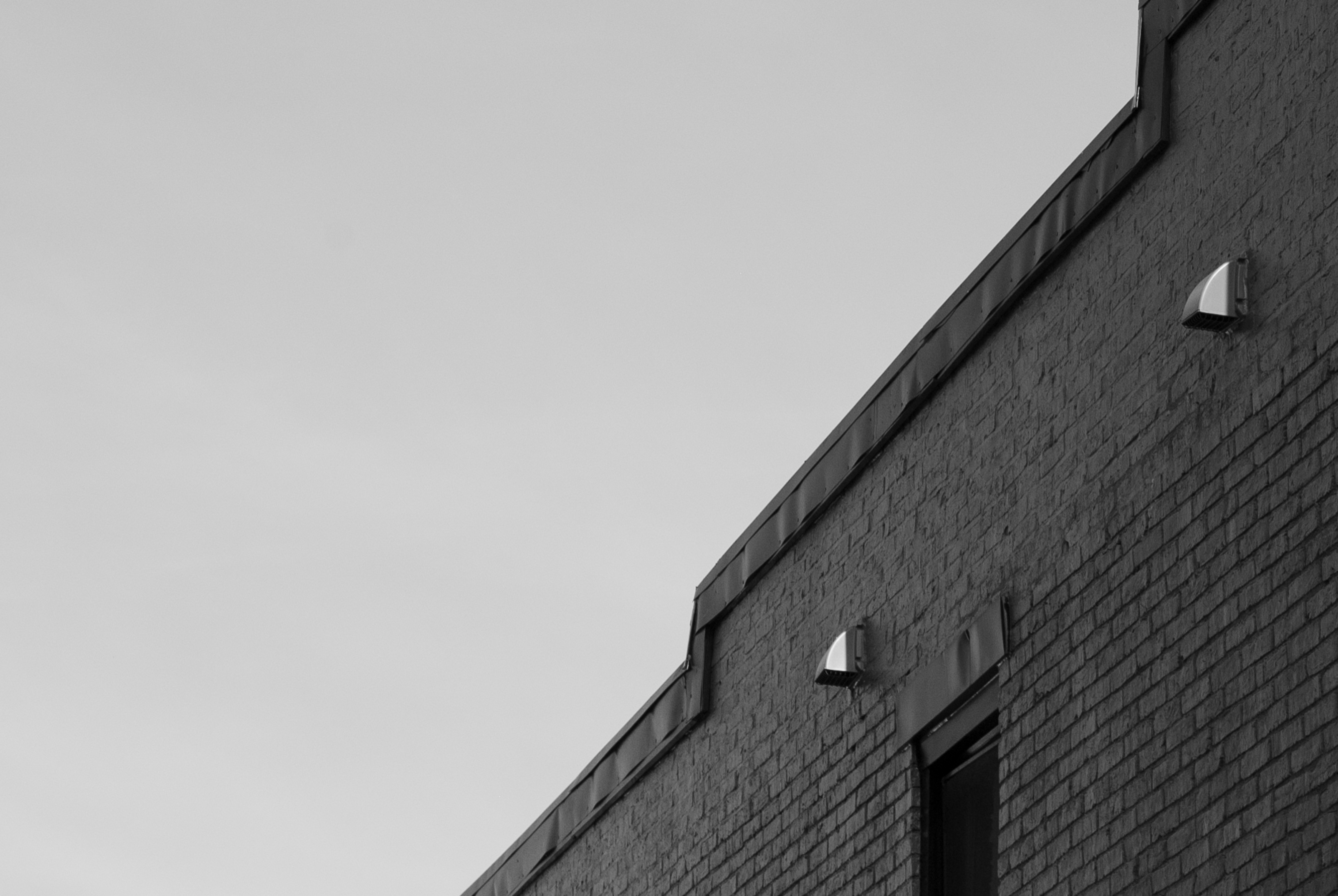 A black and white photo of a brick building photo – Free Grey Image on ...