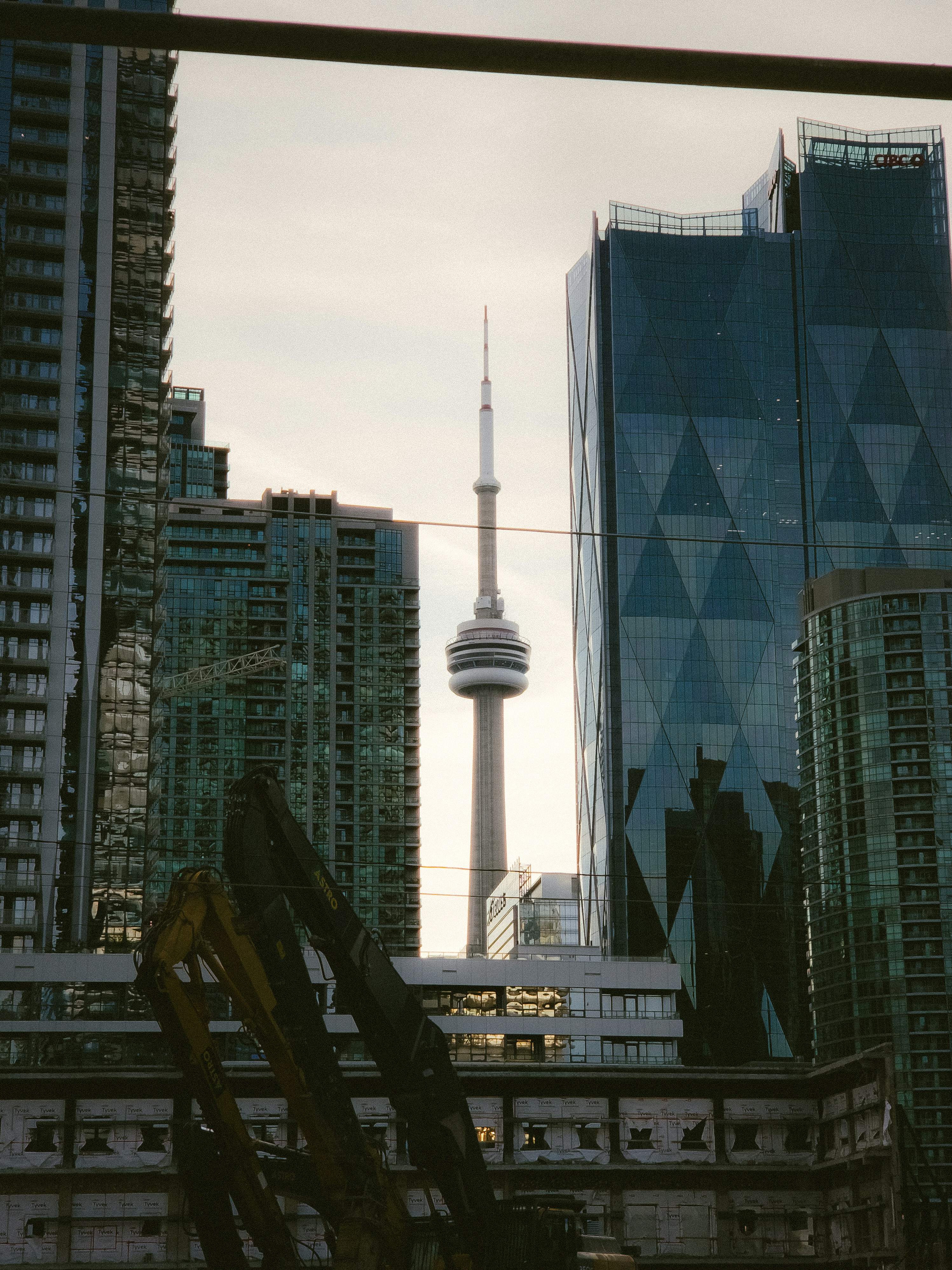 Cranes, Skyscrapers, and the CN Tower Slice through Morning Light