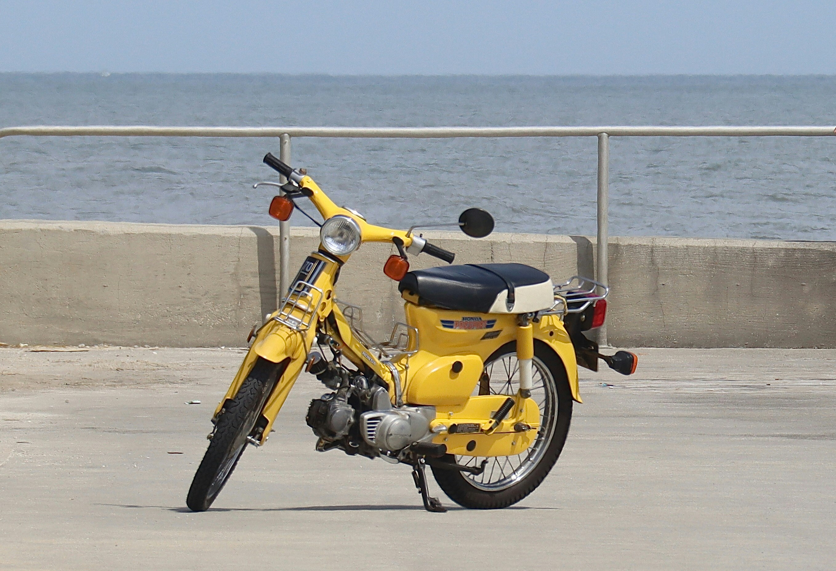 Sunlit Yellow Vintage Motorcycle by the Sea
