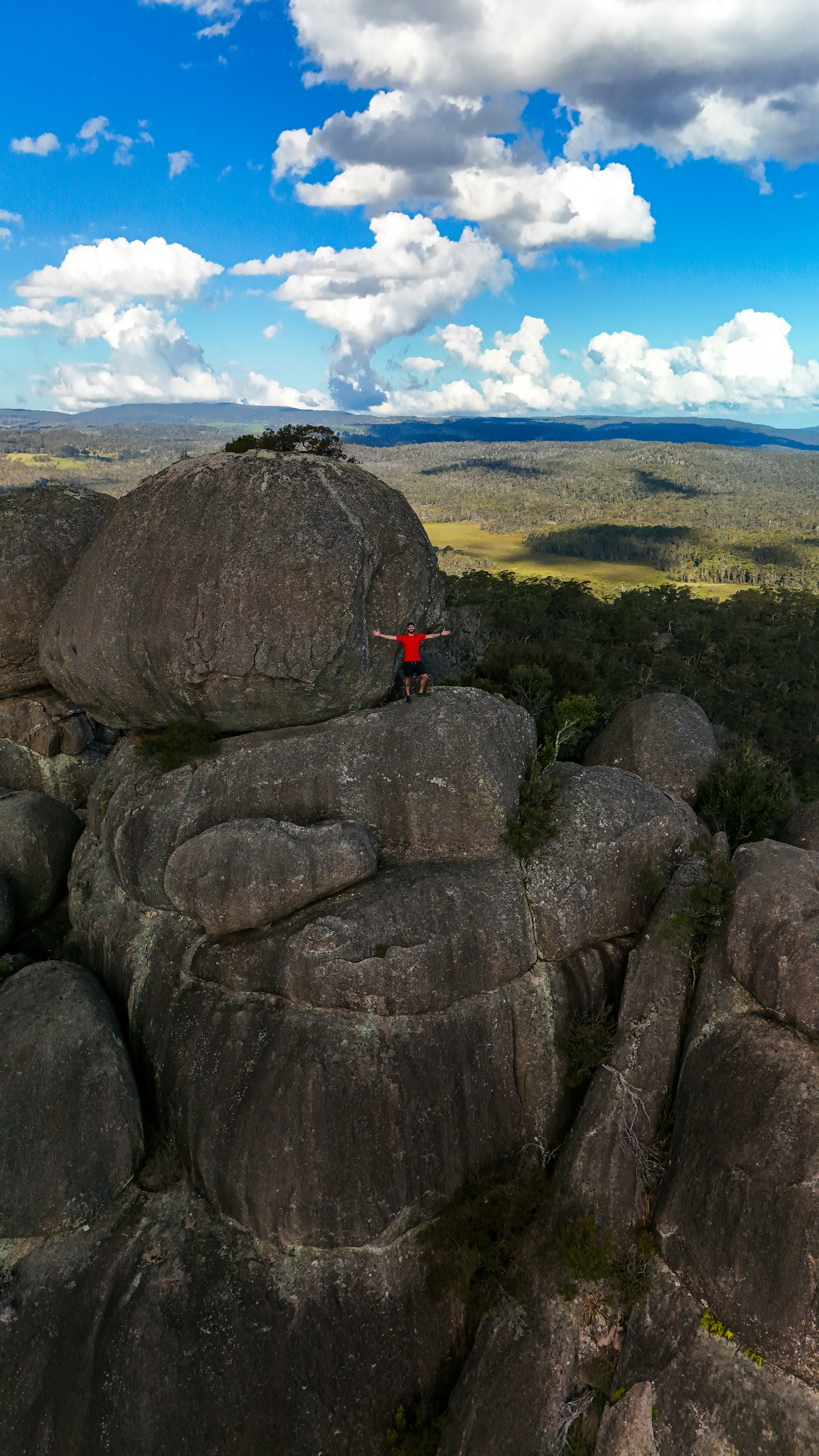 Red-Clad Figure on a Granite Throne: A Vast Rocky Panorama