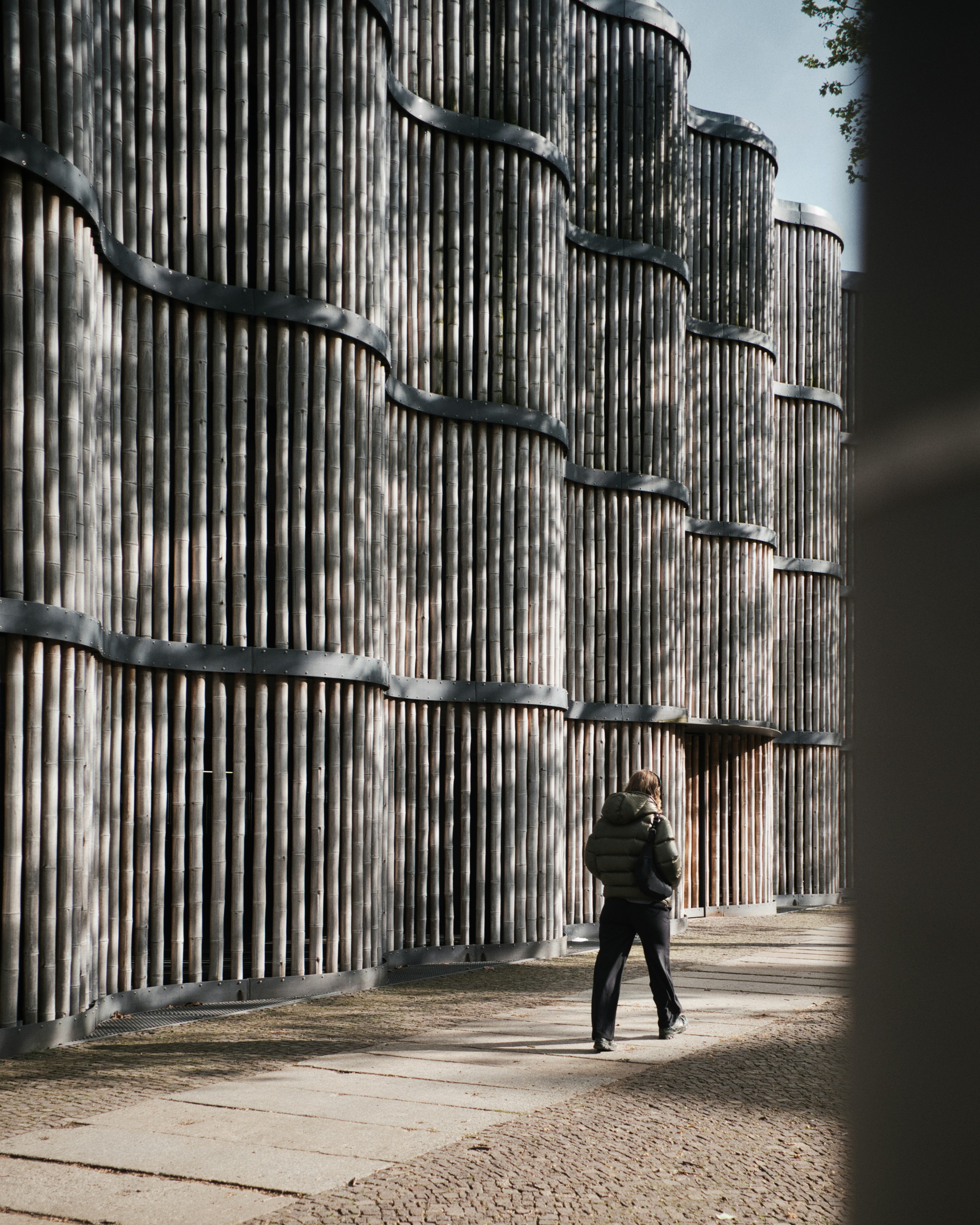 Steel Ribbons and a Solitary Pause: A Walk Along the Textured Facade