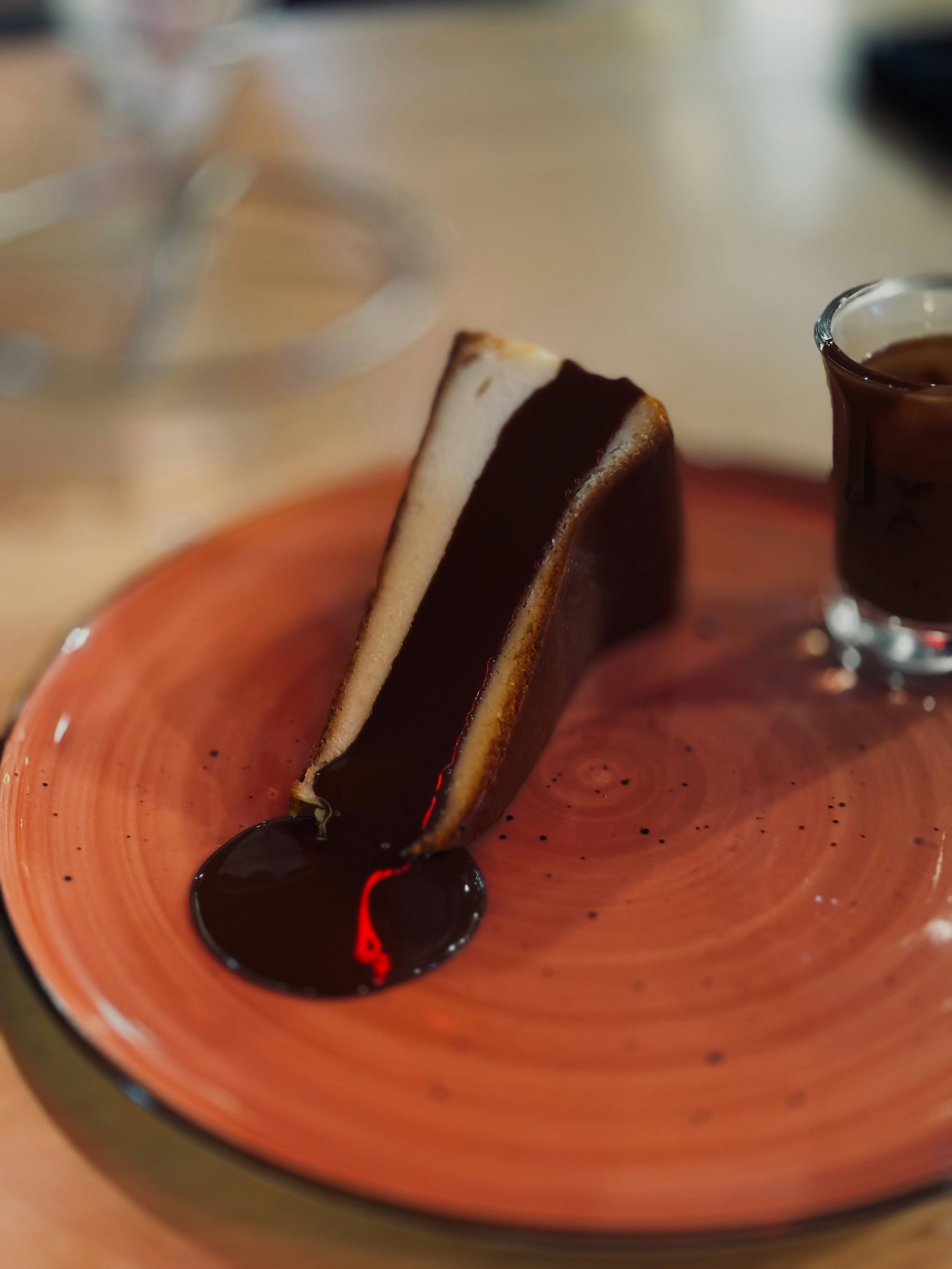Velvet Vanilla-Chocolate Slice with Cocoa Drizzle on a Coral Plate