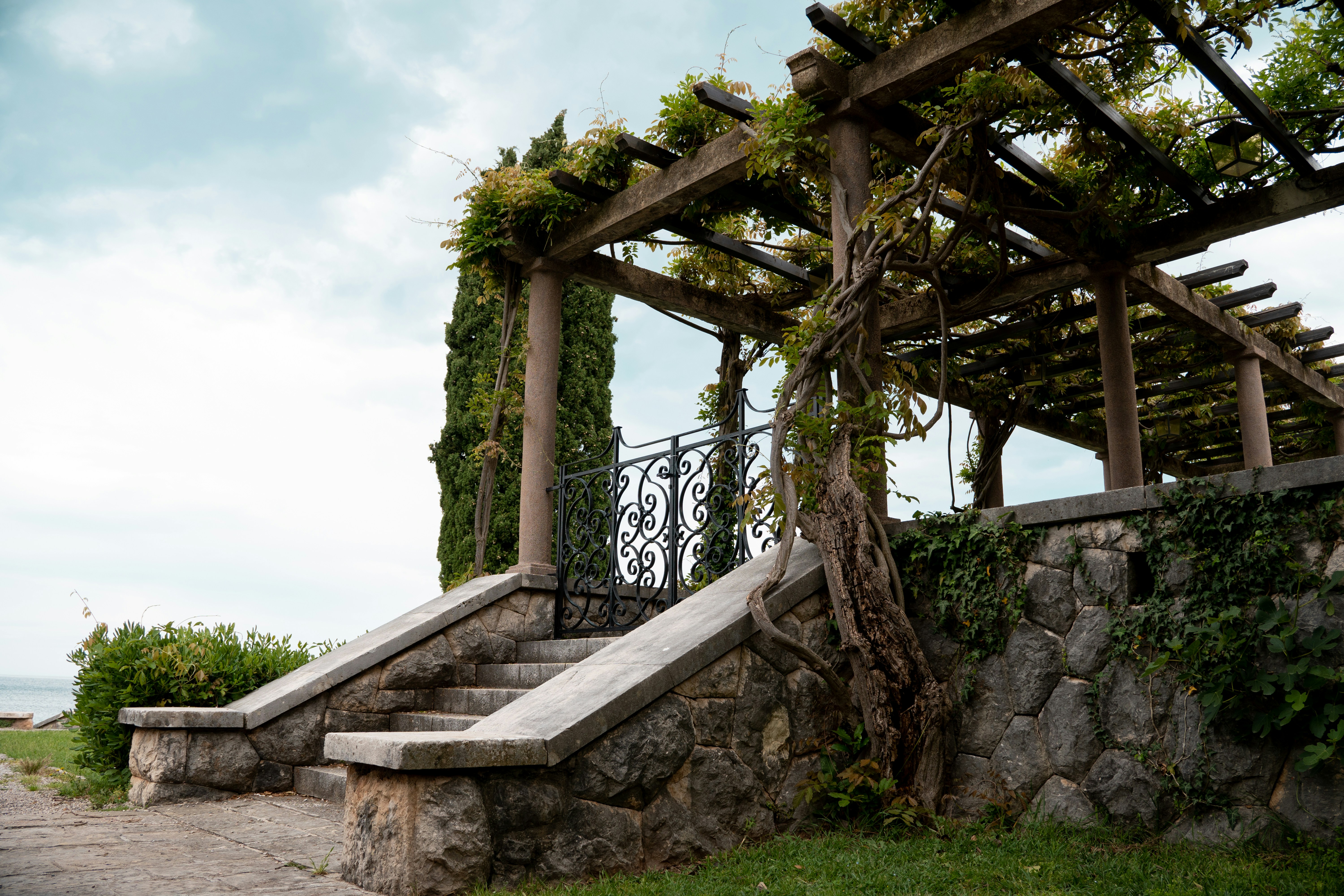 a stone structure with vines growing on it