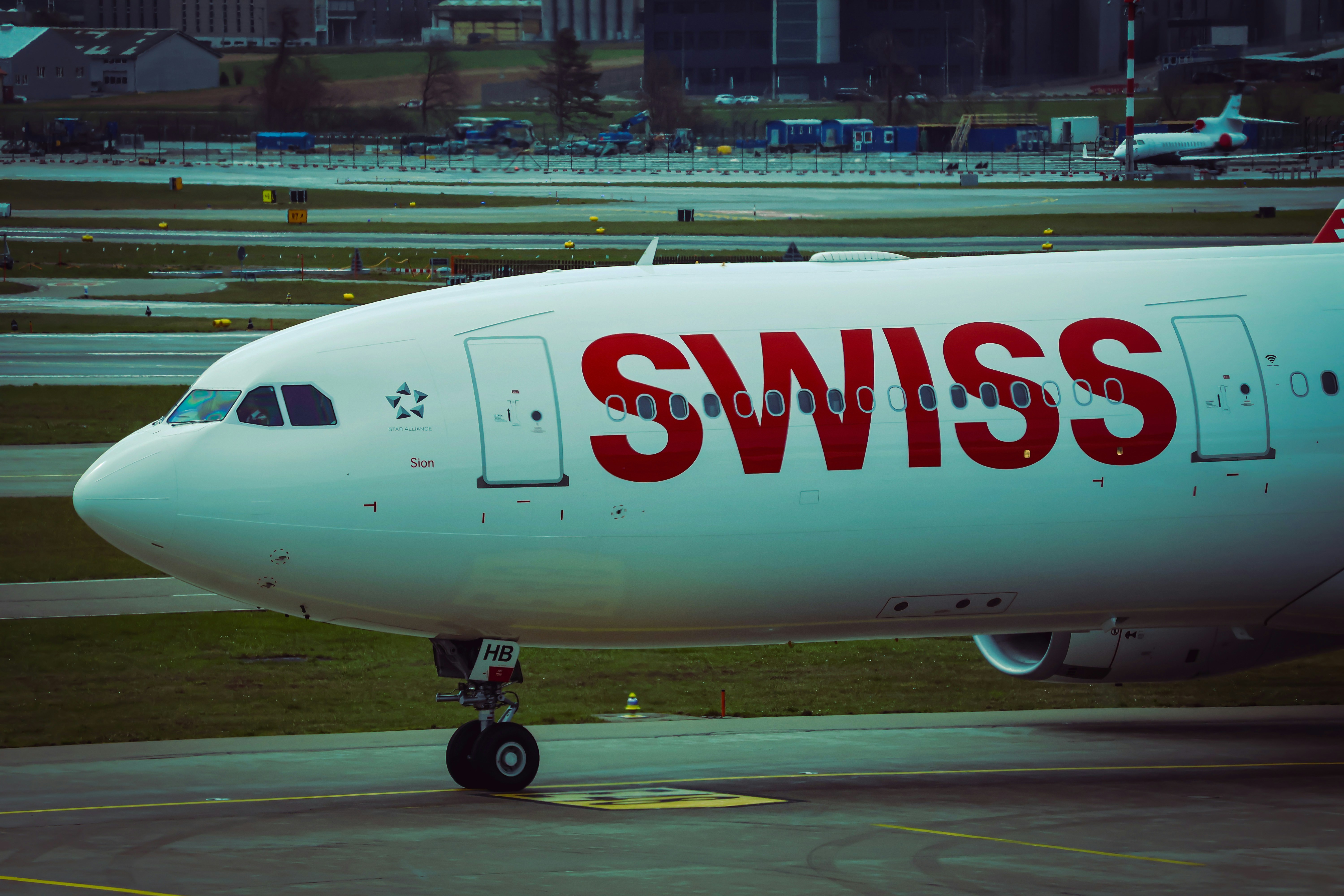 Swiss A320nosed: A Swiss aircraft at the gate under muted terminal light