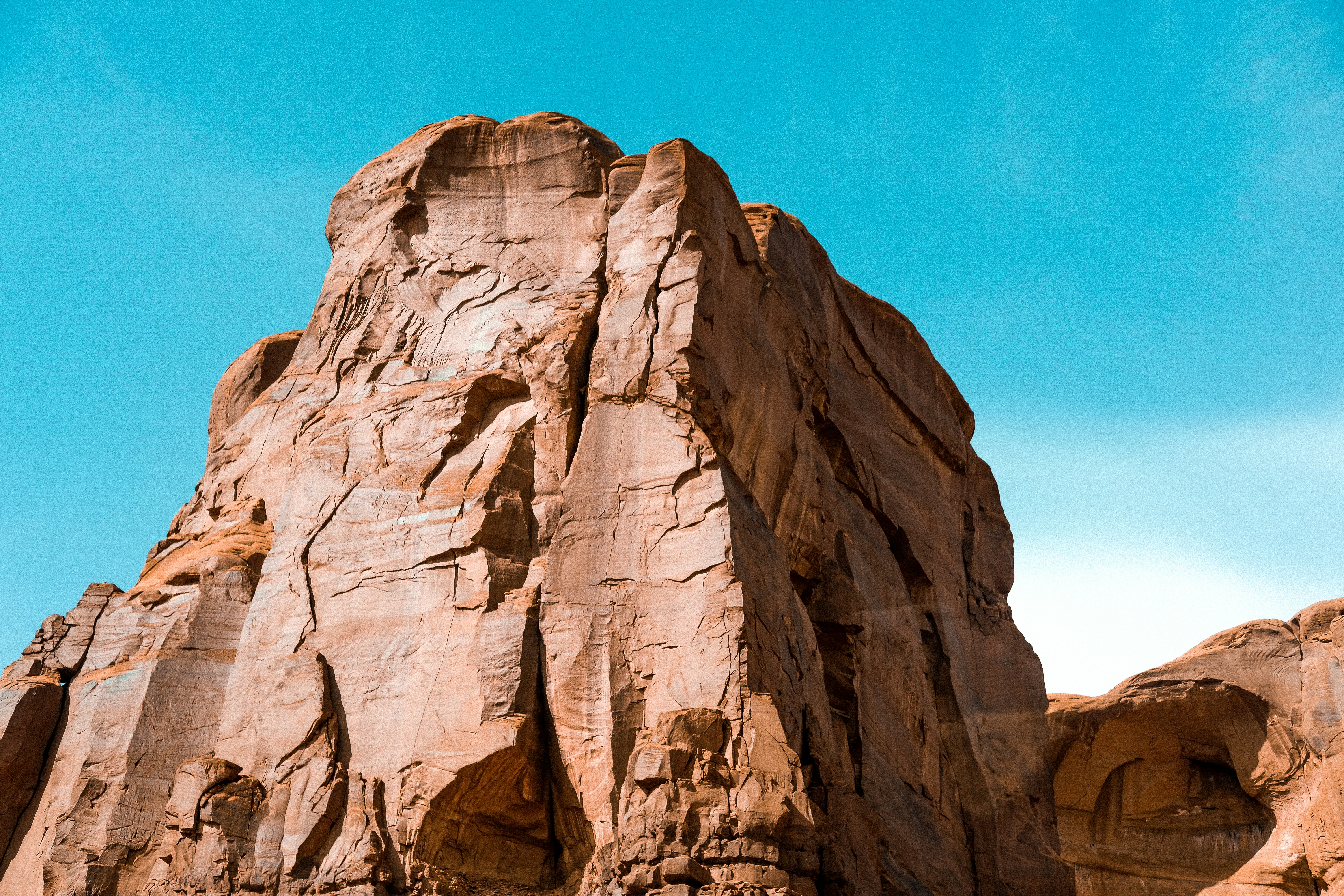 A large rock formation with a sky background photo – Free Rock Image on ...