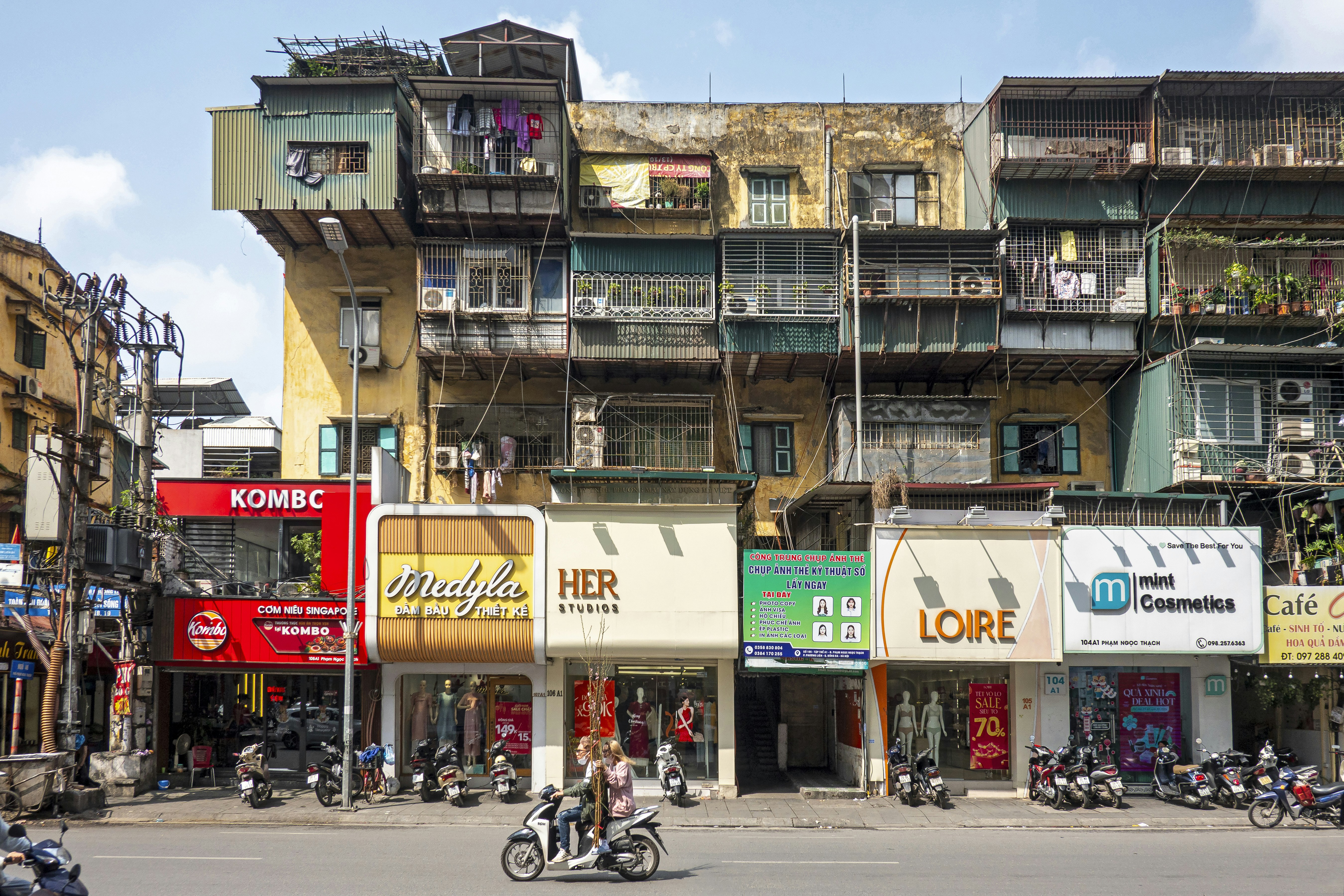 residential building with balconies and storefronts in hanoi, vietnam