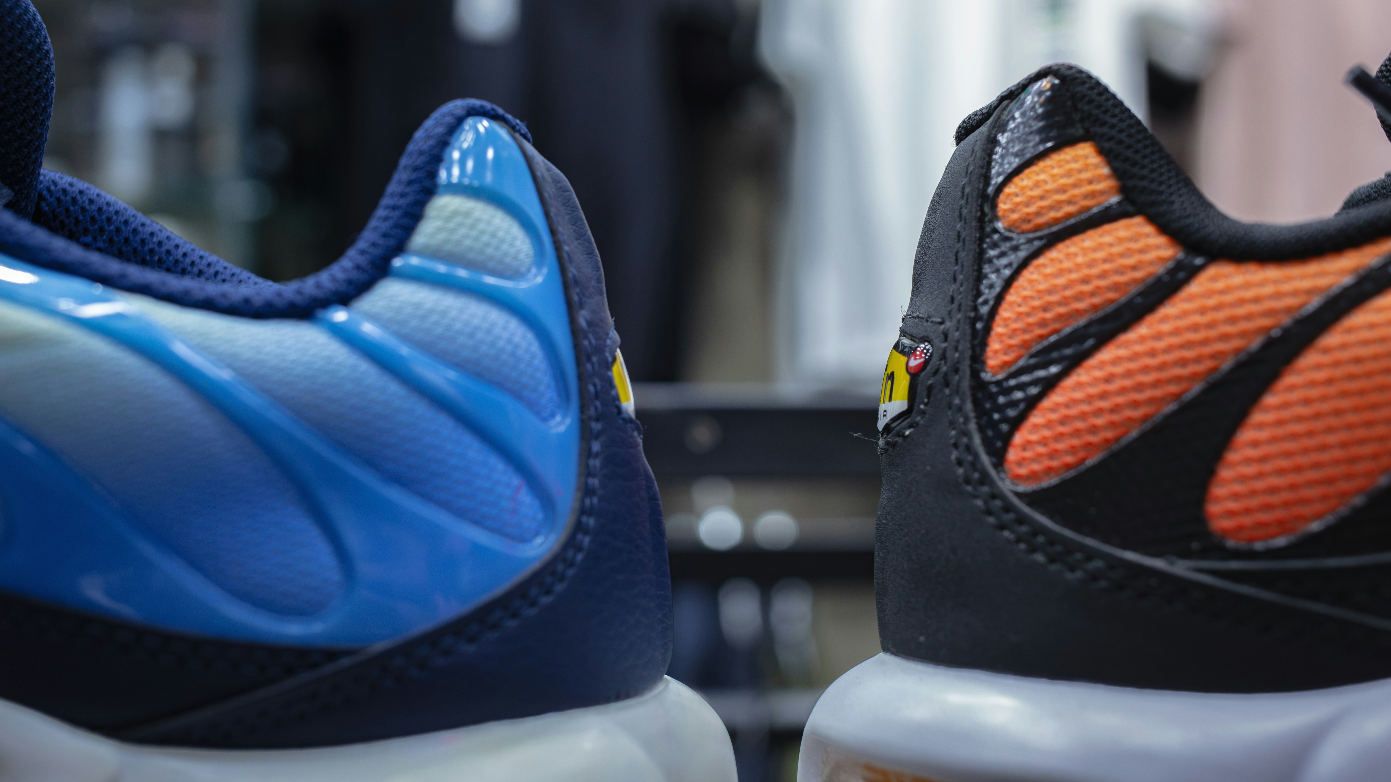 Close-up of two sneaker designs showcasing contrasting colors and textures, highlighting the unique features of each shoe.
