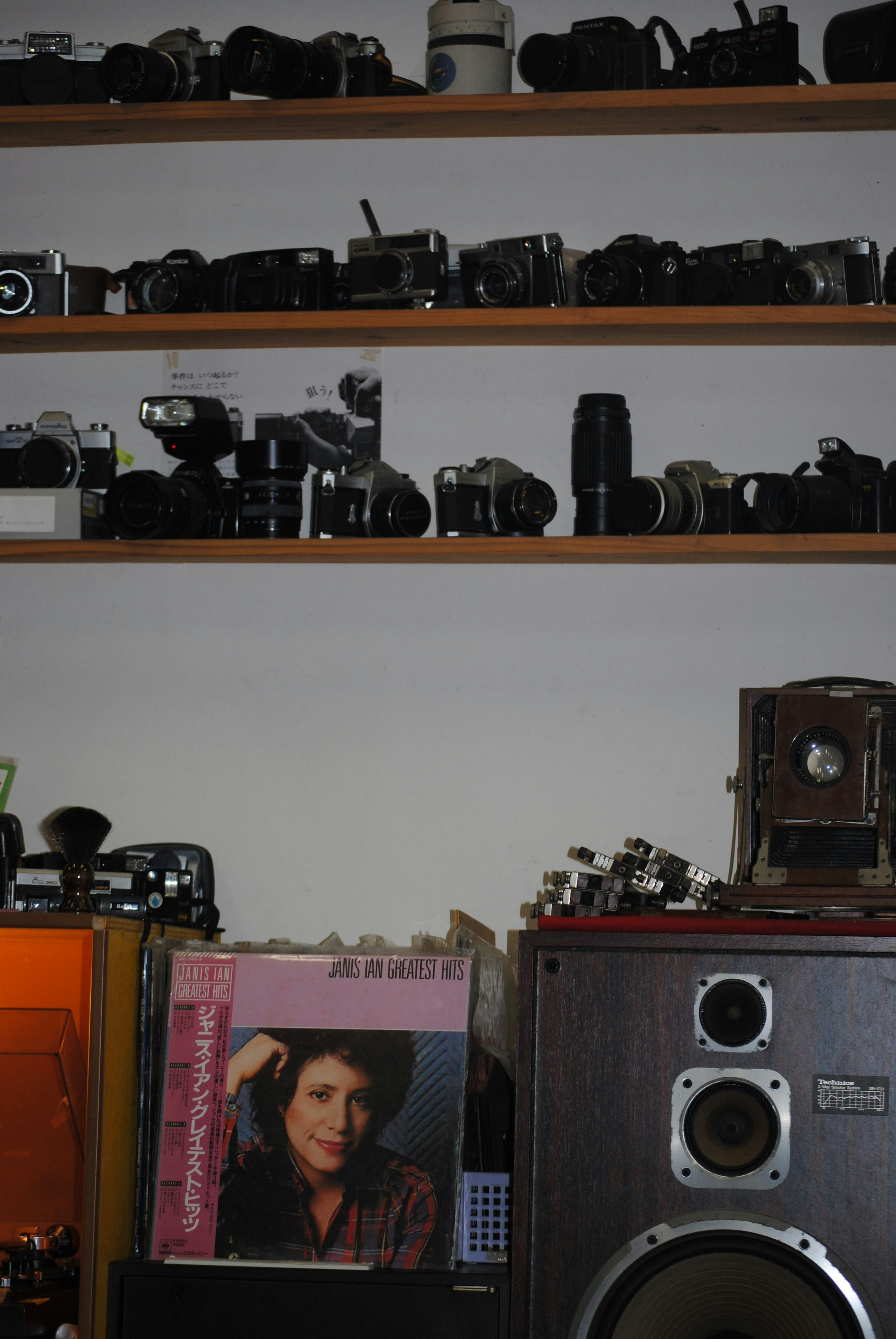 Analog Archive: A Wall of Vintage Cameras Anchored by a Vinyl Portrait