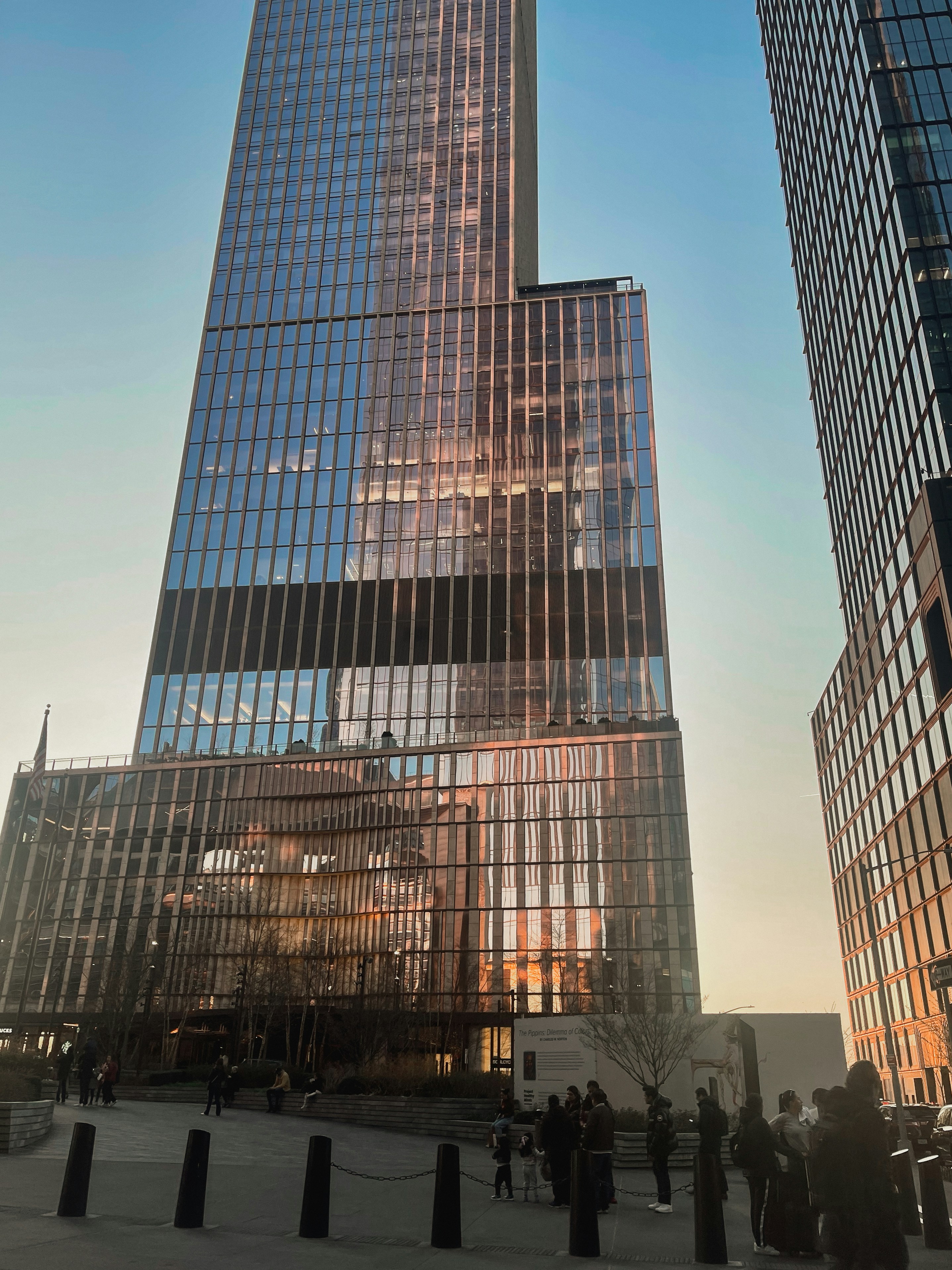 A group of people standing in front of a tall building photo – Free ...