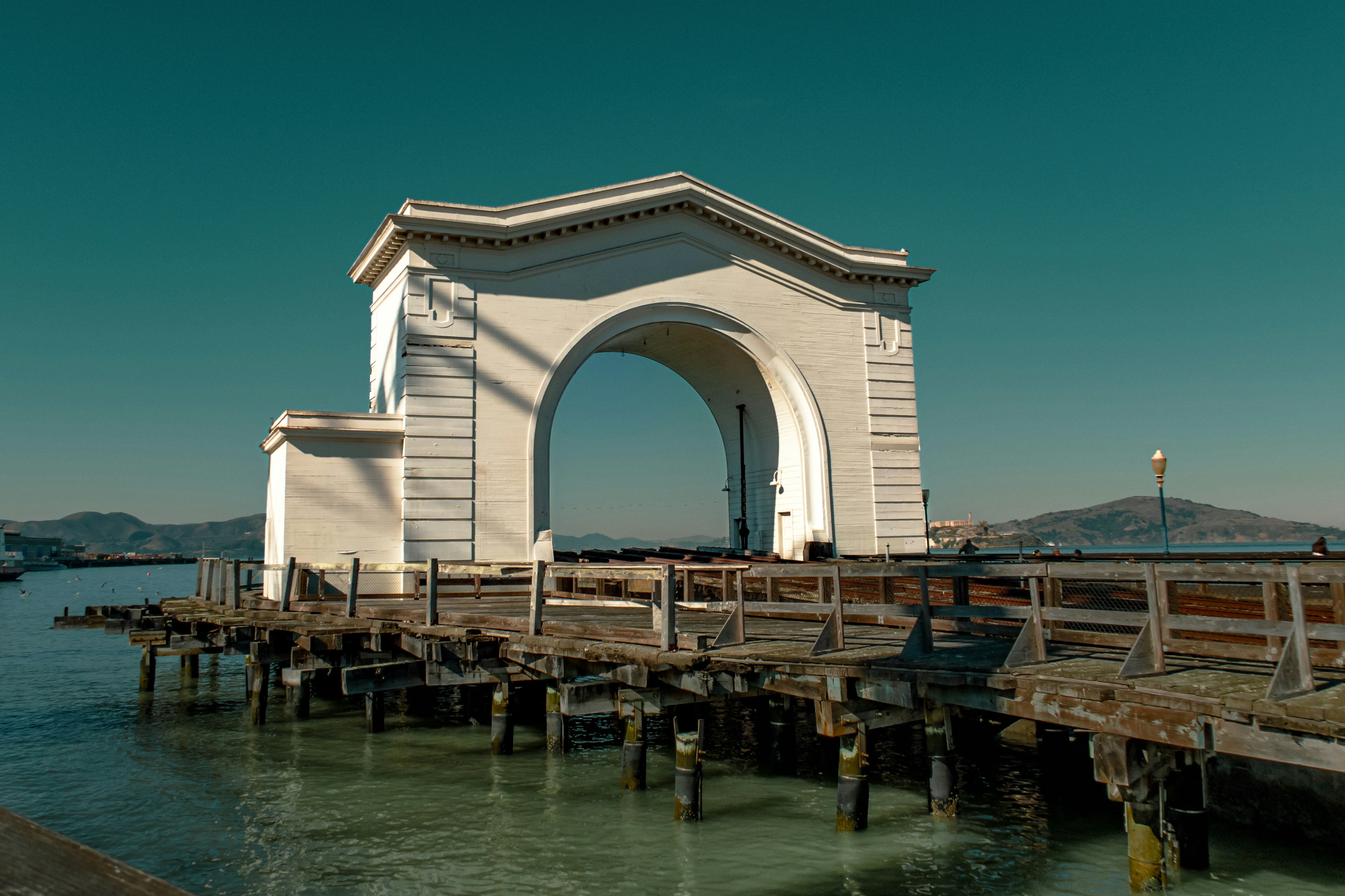 Teal Hour Arch Pier: A Quiet Gateway Over Calm Seawater
