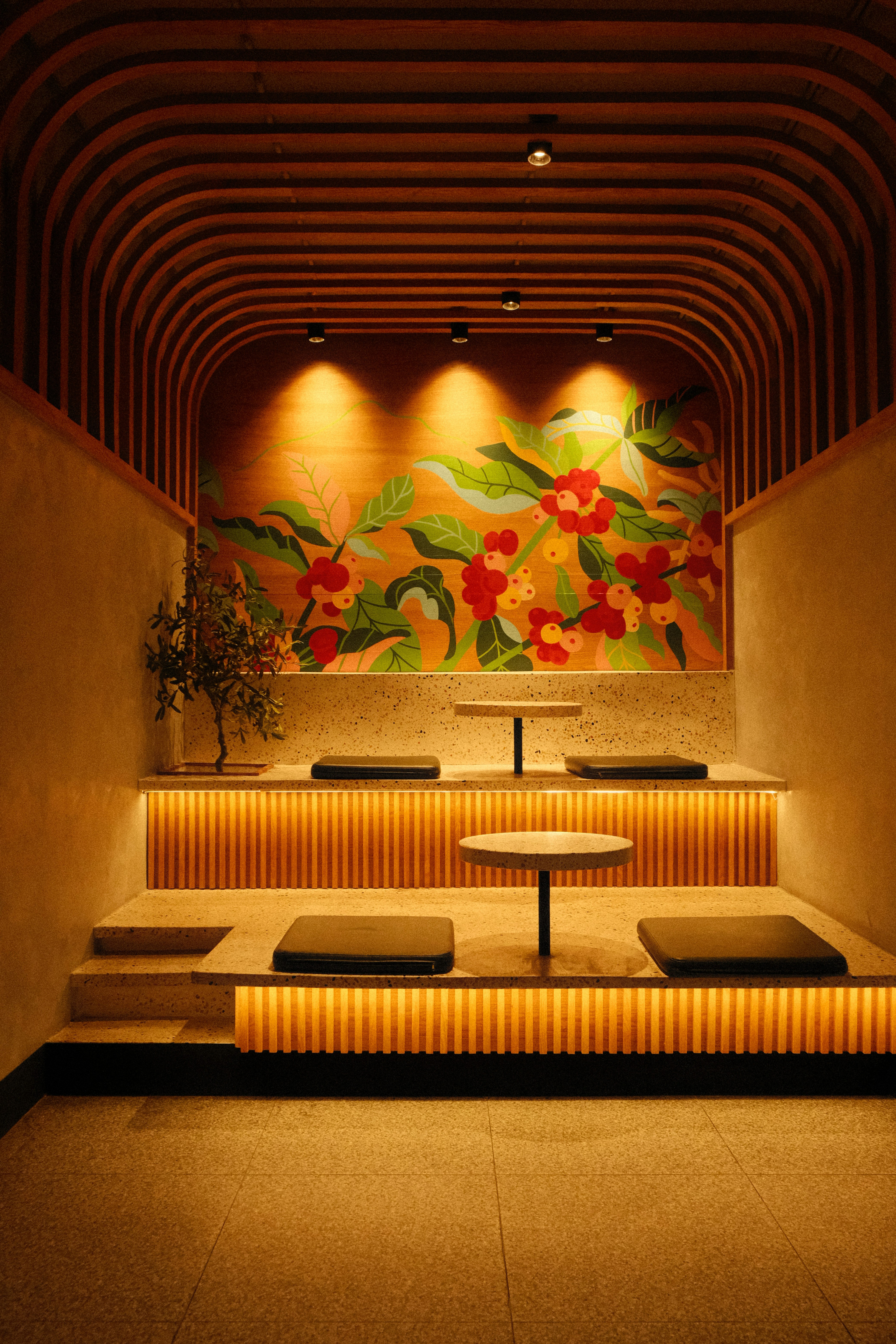 A dimly lit room with benches and a painting on the wall photo – Free ...