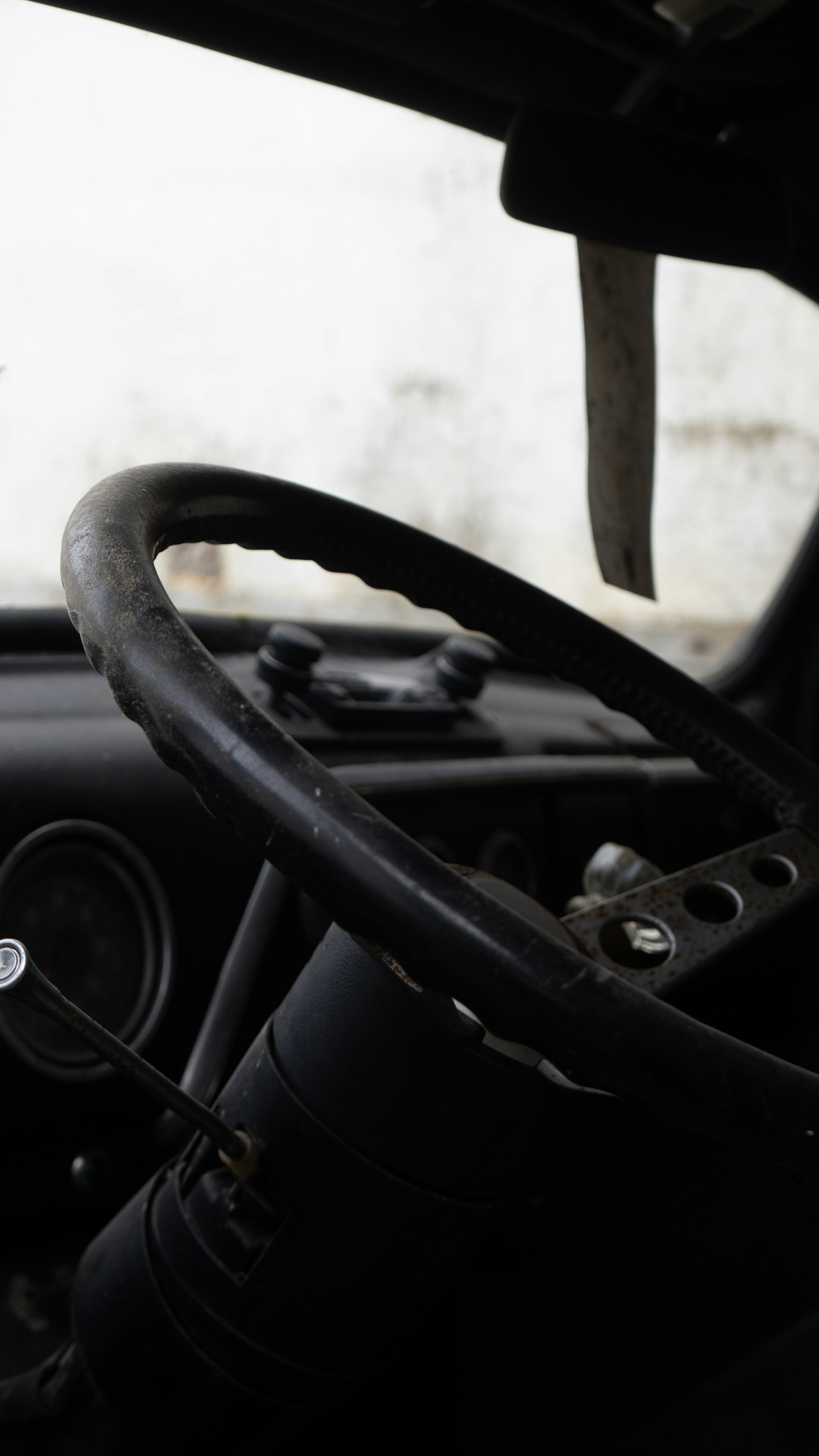 Rusted Rim, Quiet Interior: A Close-Quarter Portrait of a Vintage Car