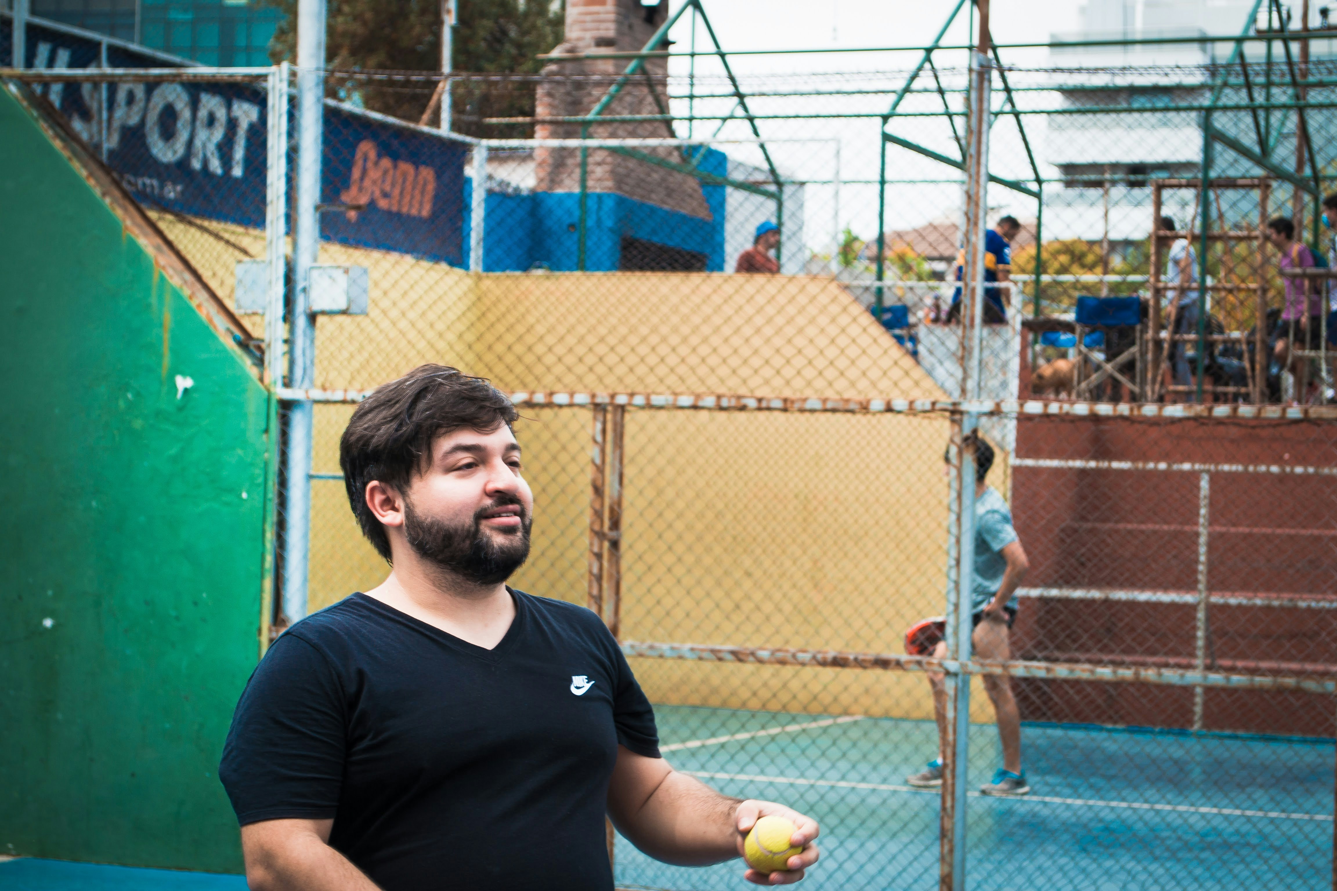 A man holding a tennis ball and a tennis racquet photo – Free Man Image ...