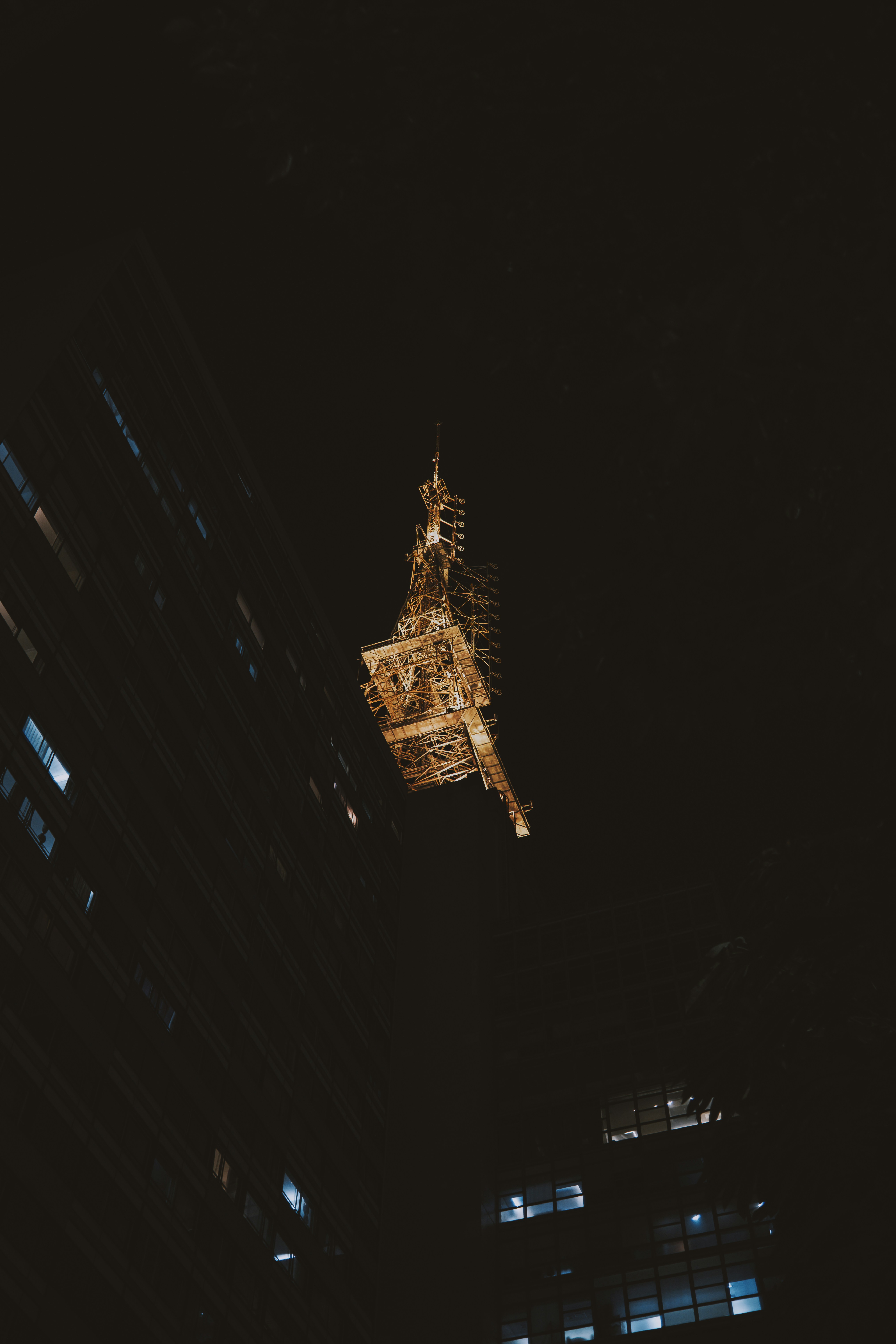 A very tall tower towering over a city at night photo – Free City Image ...