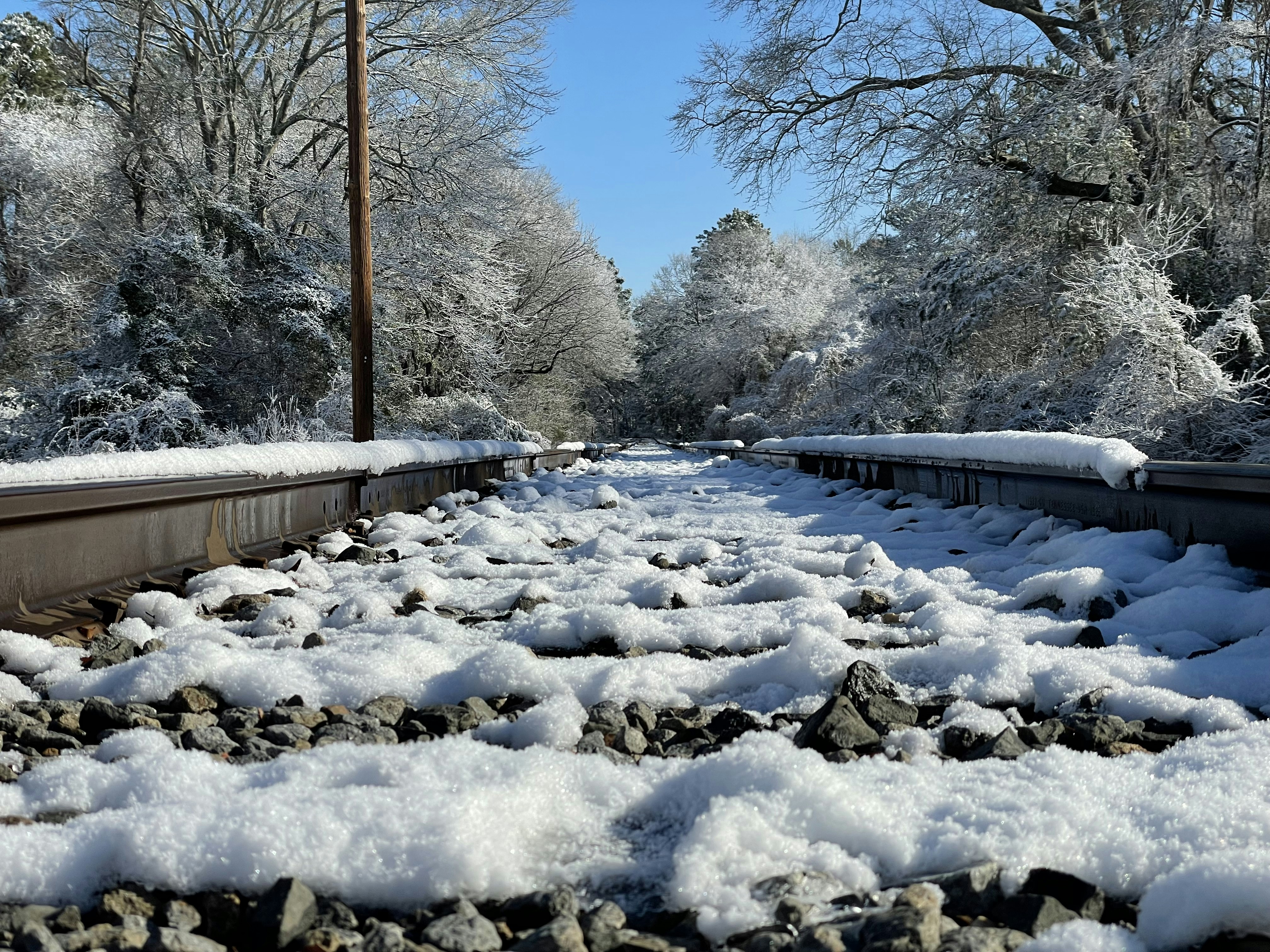 Snowbound Rails: A Cold Perspective through Frosted Tracks
