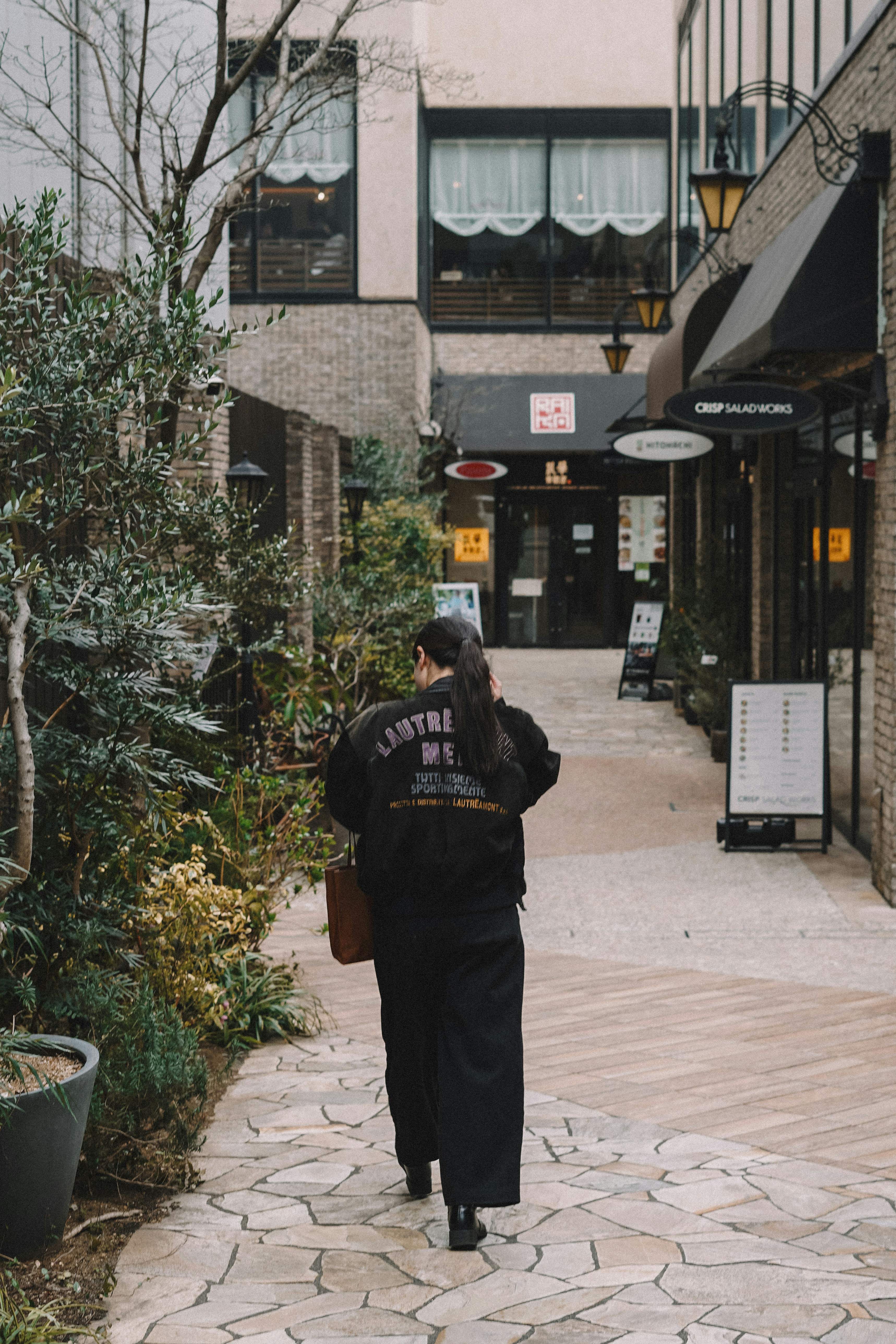 A Quiet Backward Walk Through a Stone-Paved Alley