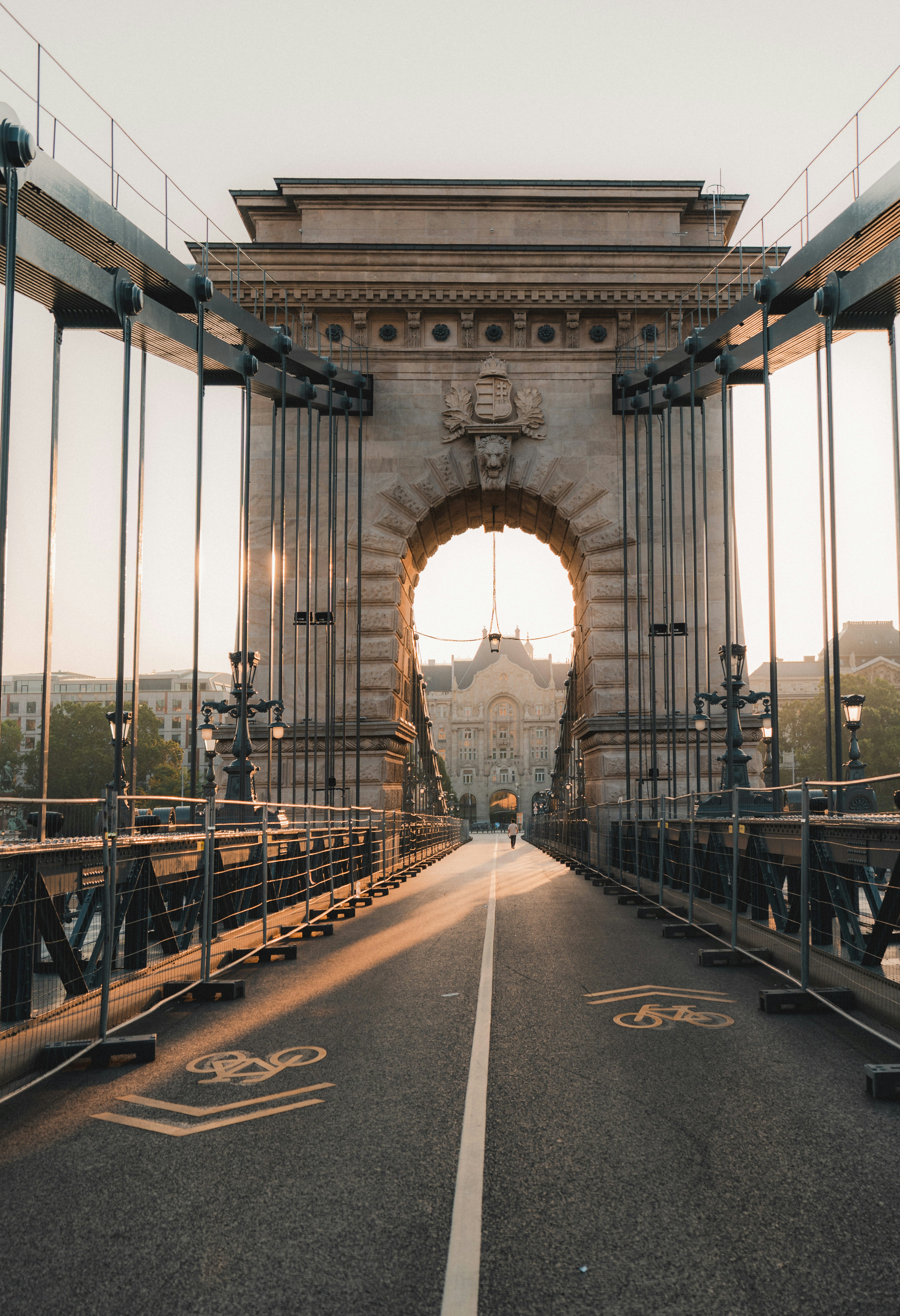 A person walking across a bridge over a river photo – Free Travel Image ...