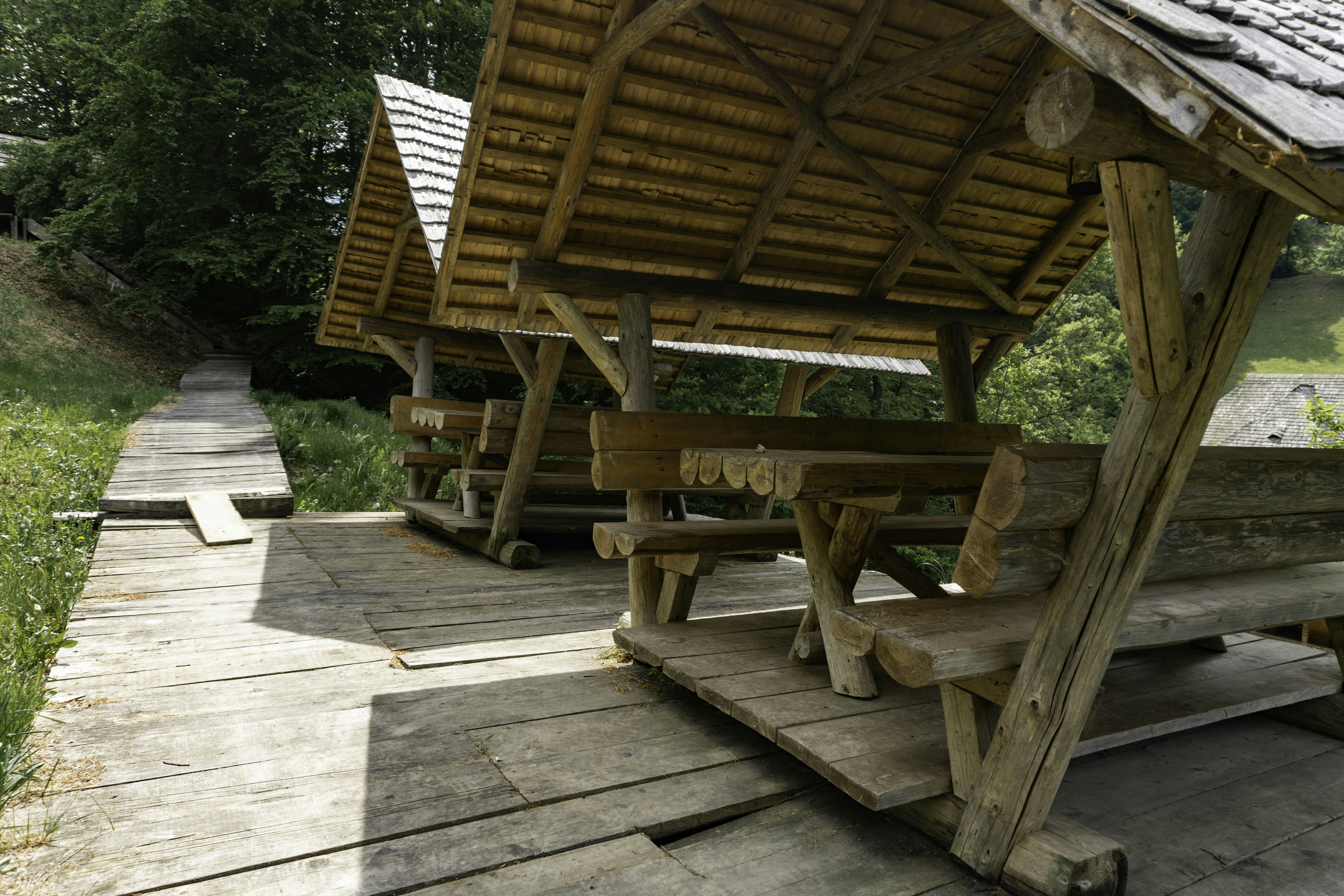 A group of wooden benches sitting next to each other photo – Free ...