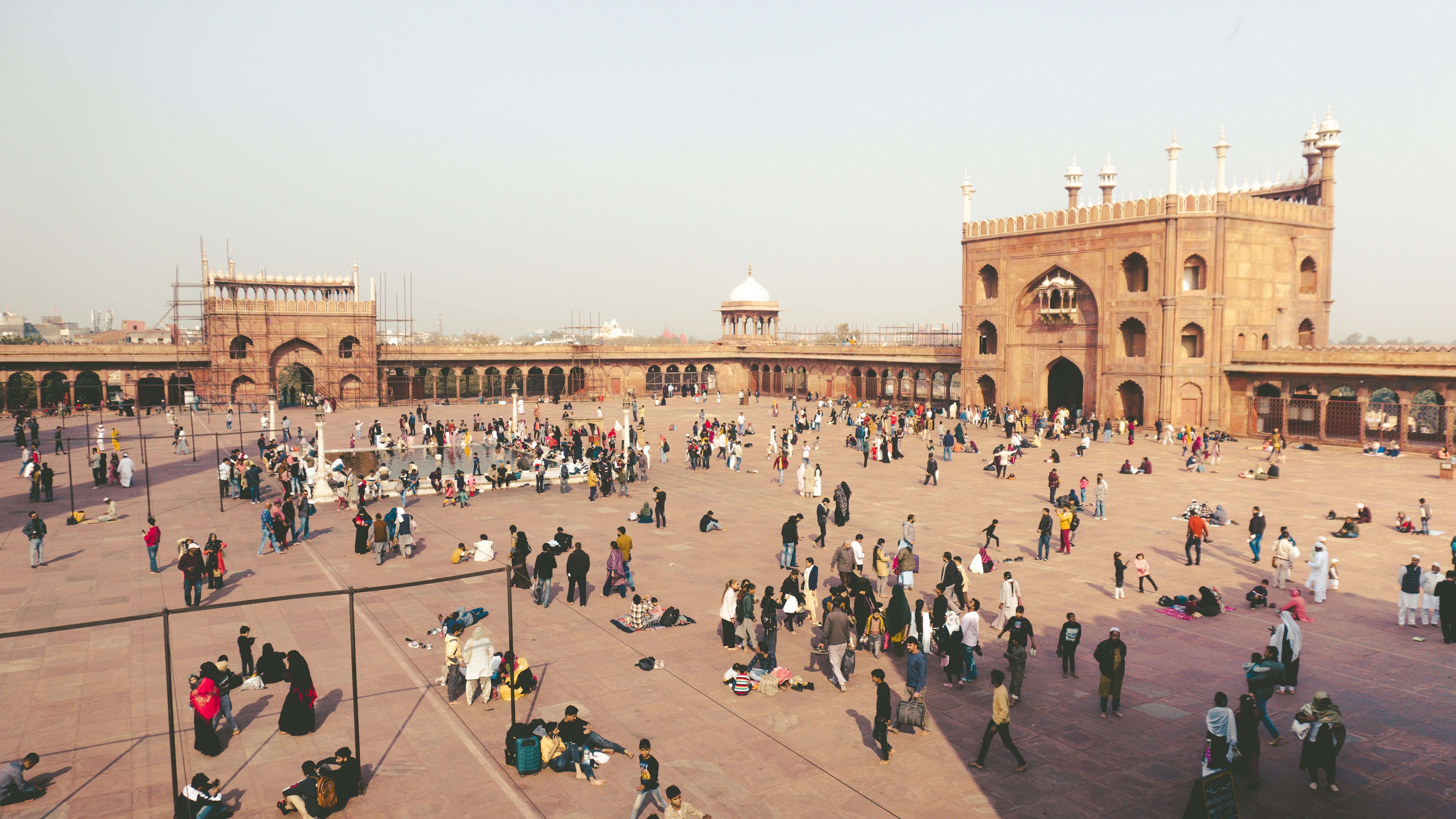 Sunlit Plaza Beneath Twin Arches: A Tapestry of Daily Life