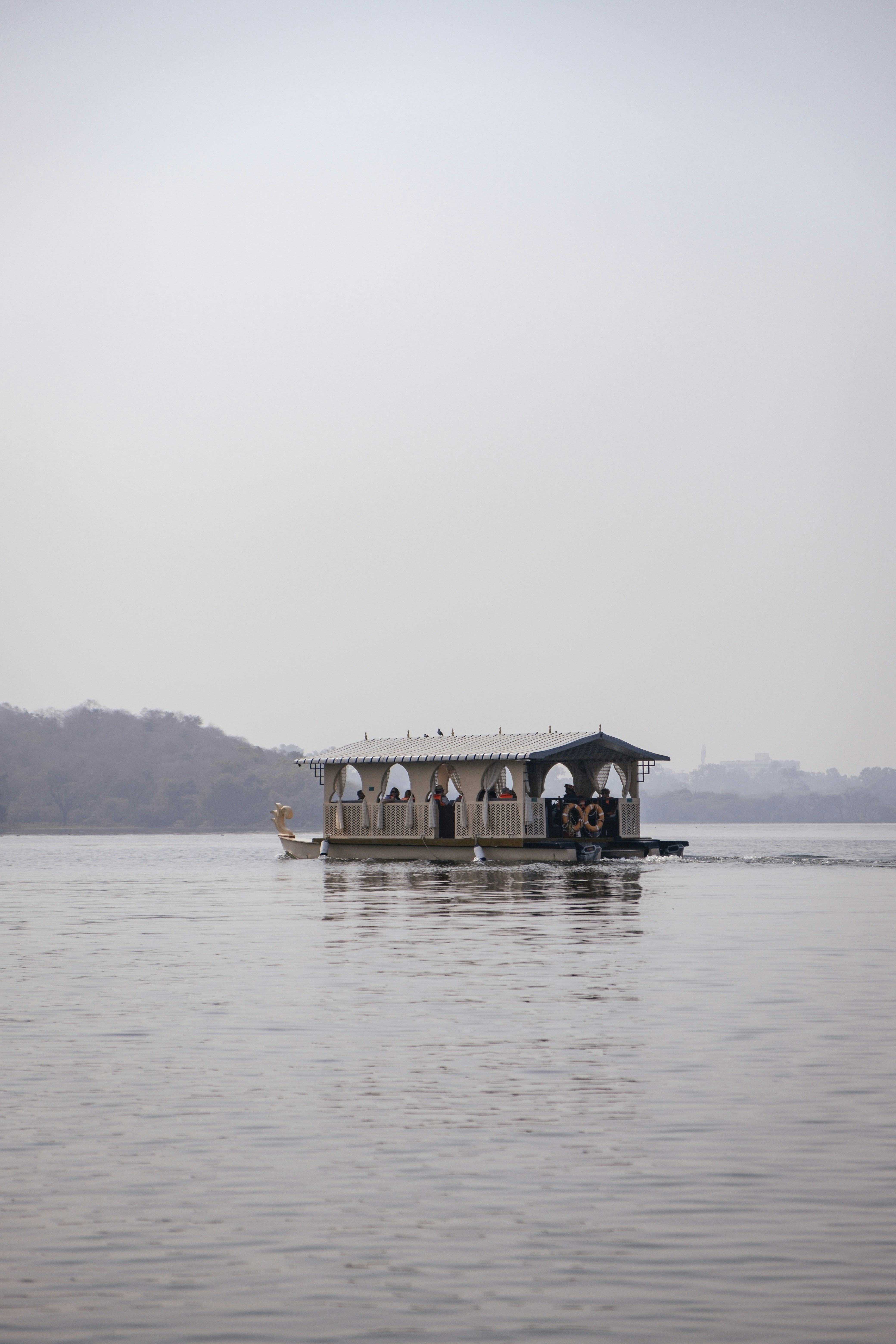Mist-Lapped Barque Drifts Across a Quiet Lake