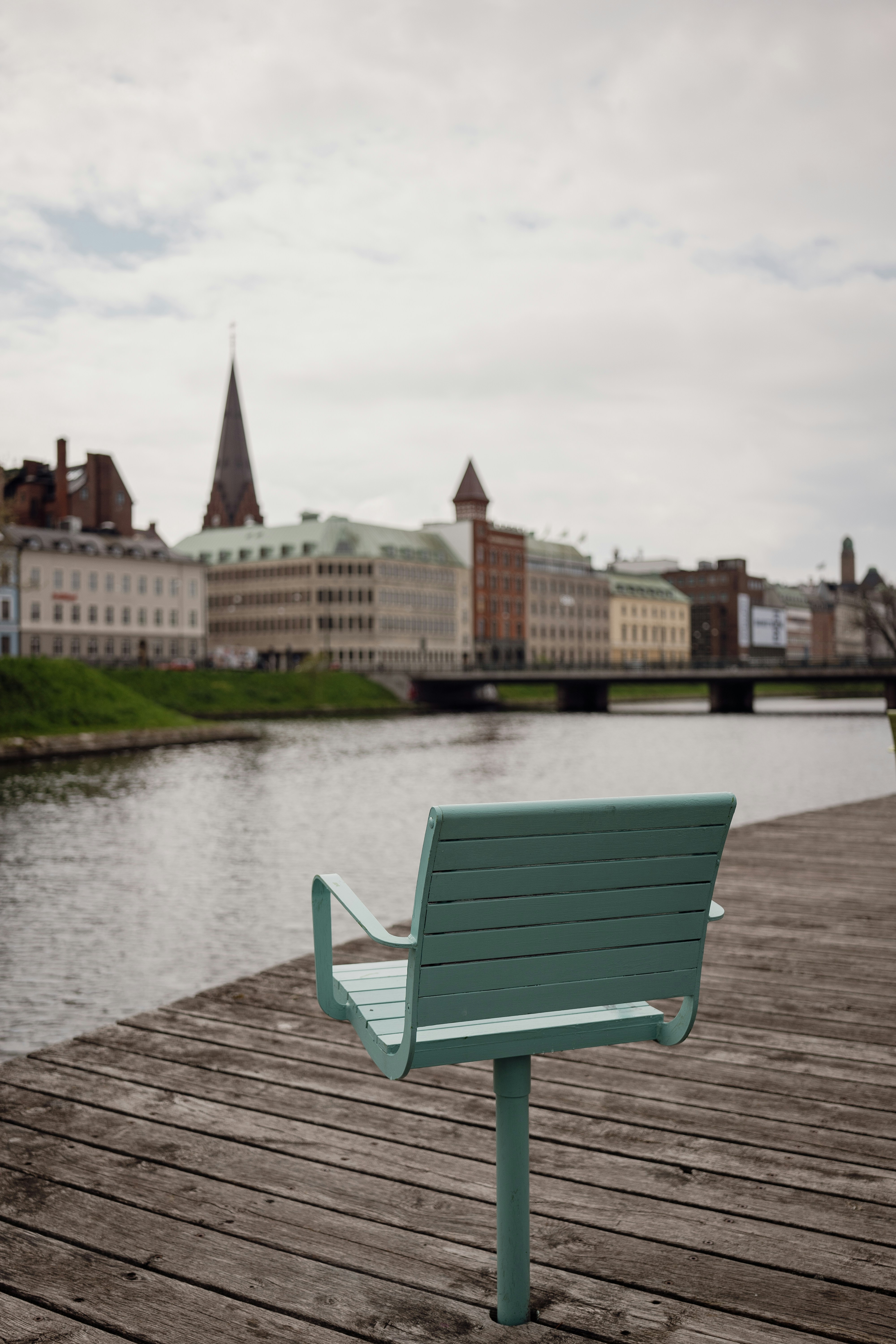 Green Bench by the River: A Quiet Vantage on a European Waterfront