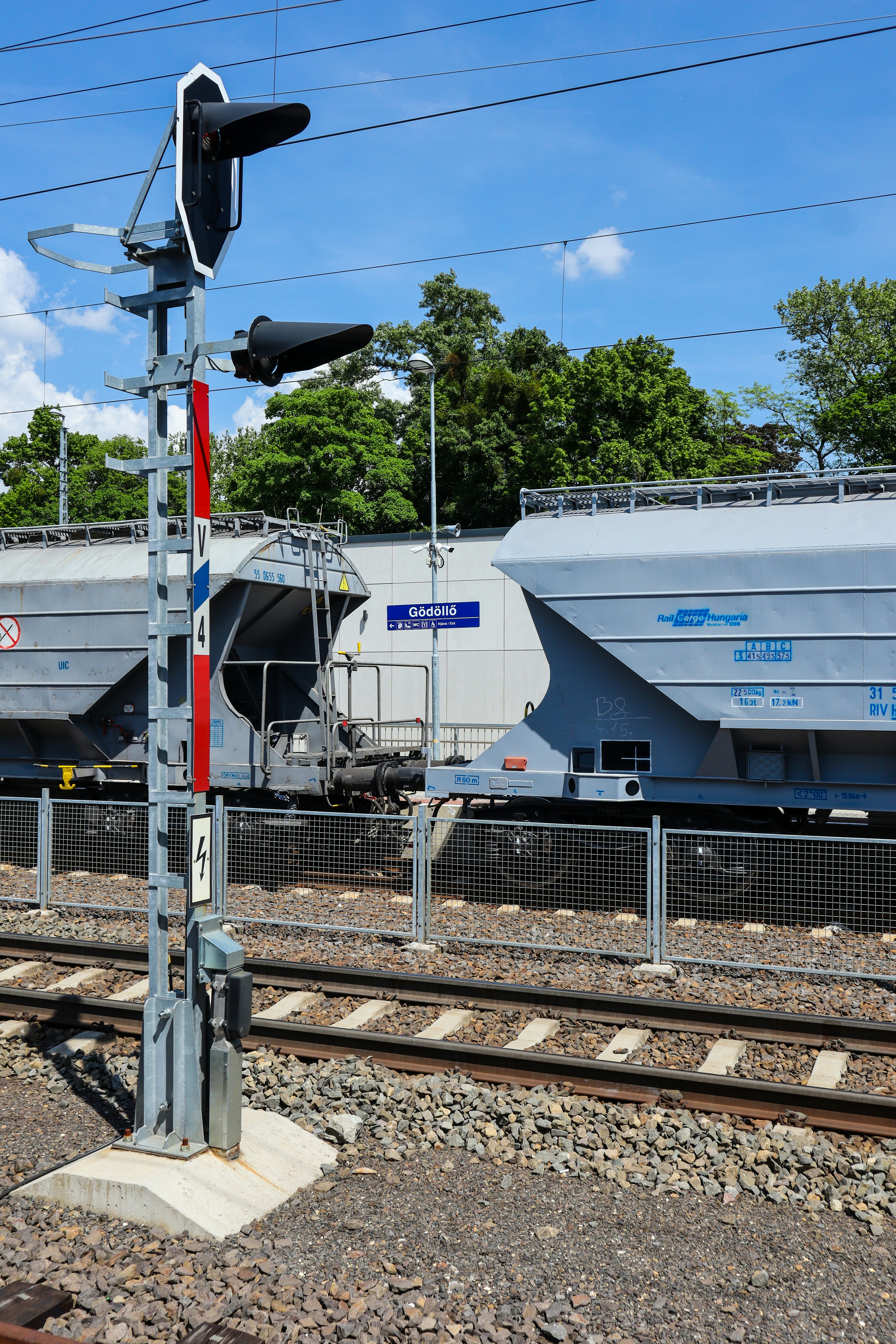 Industrial Geometry: The Signal Post Framing a Freight Yard Under a Clear Sky