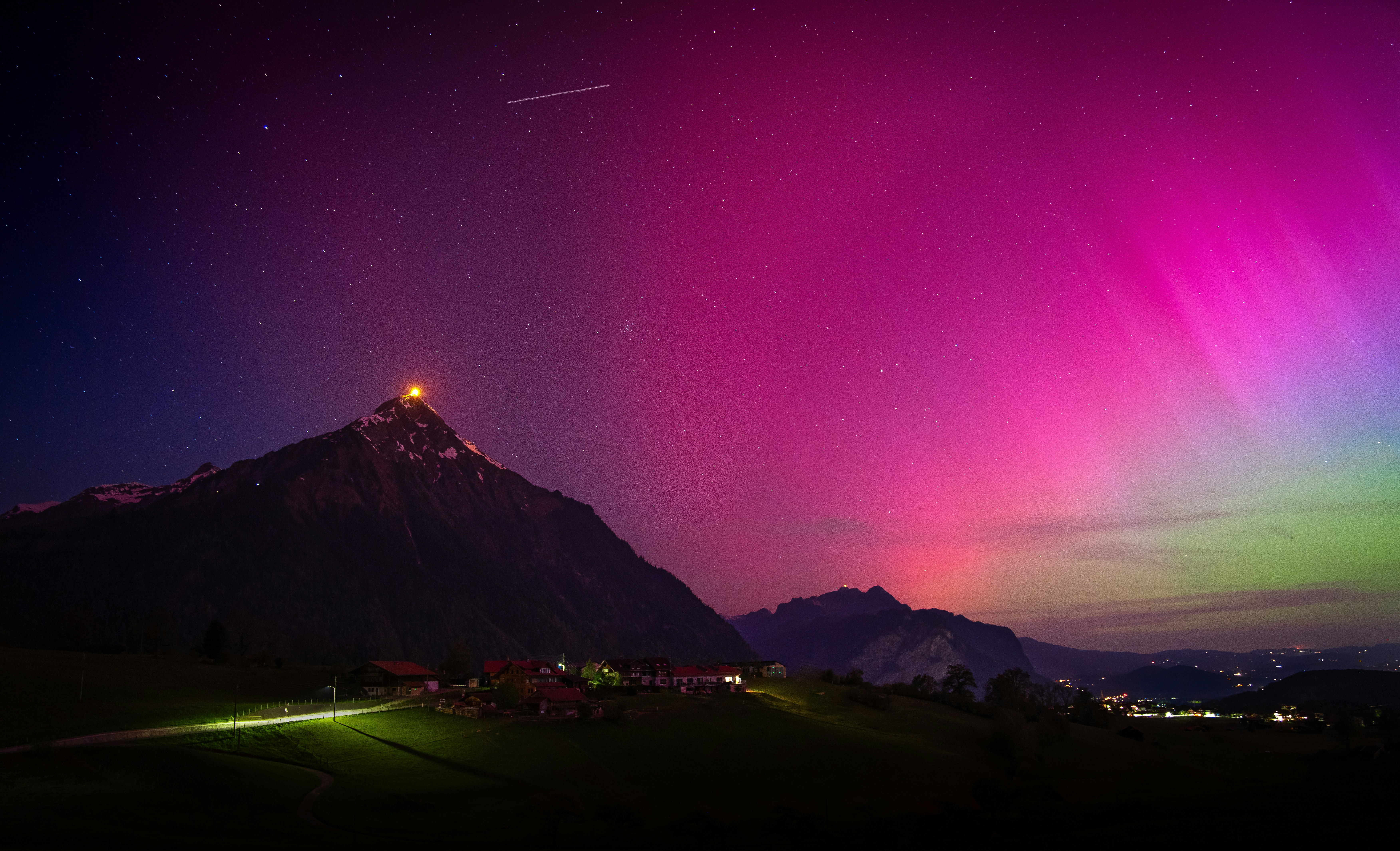 Aurora Ridge: Night Sky Over the Alpine Village