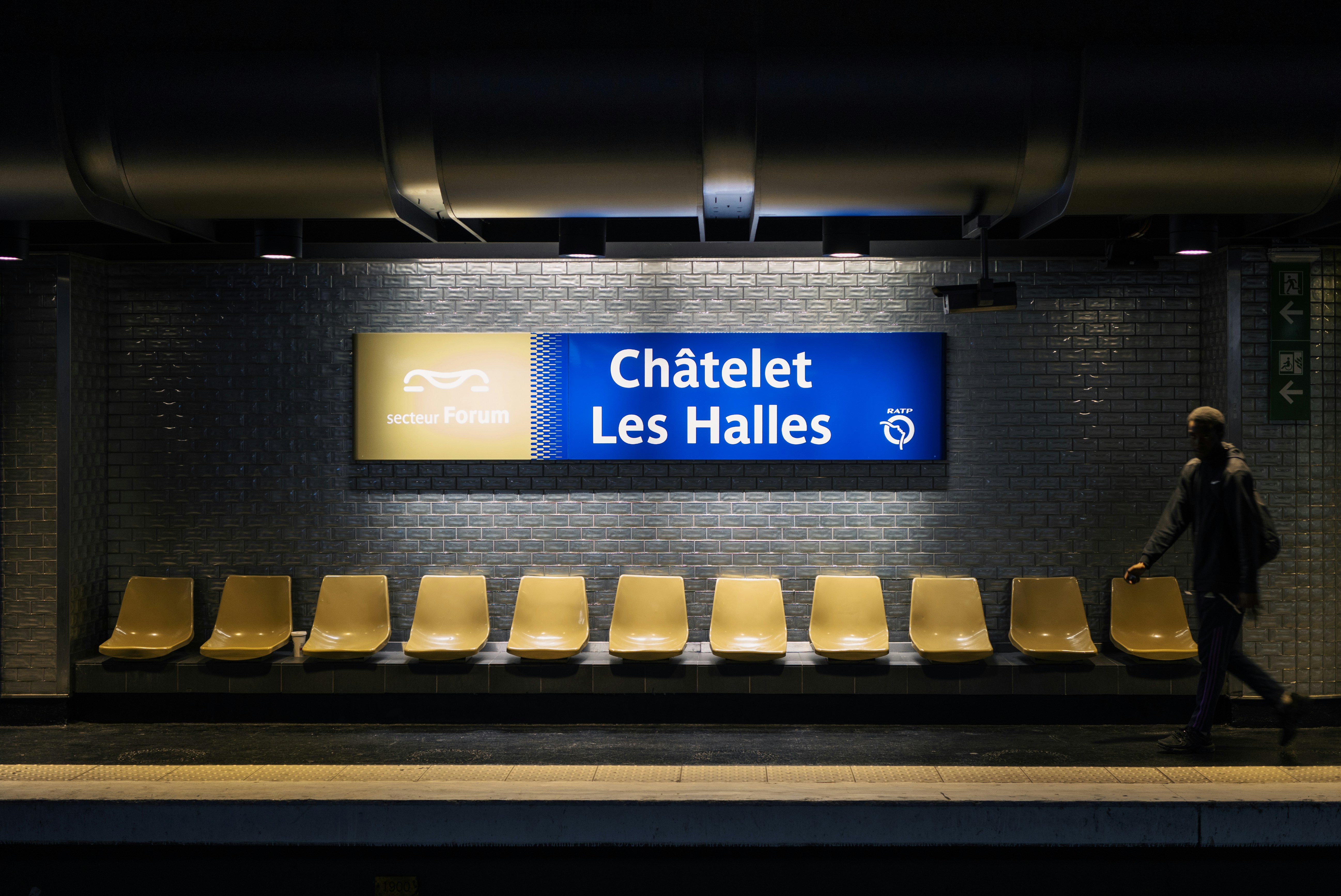 Blue Sign Over Empty Seats at Châtelet–Les Halles