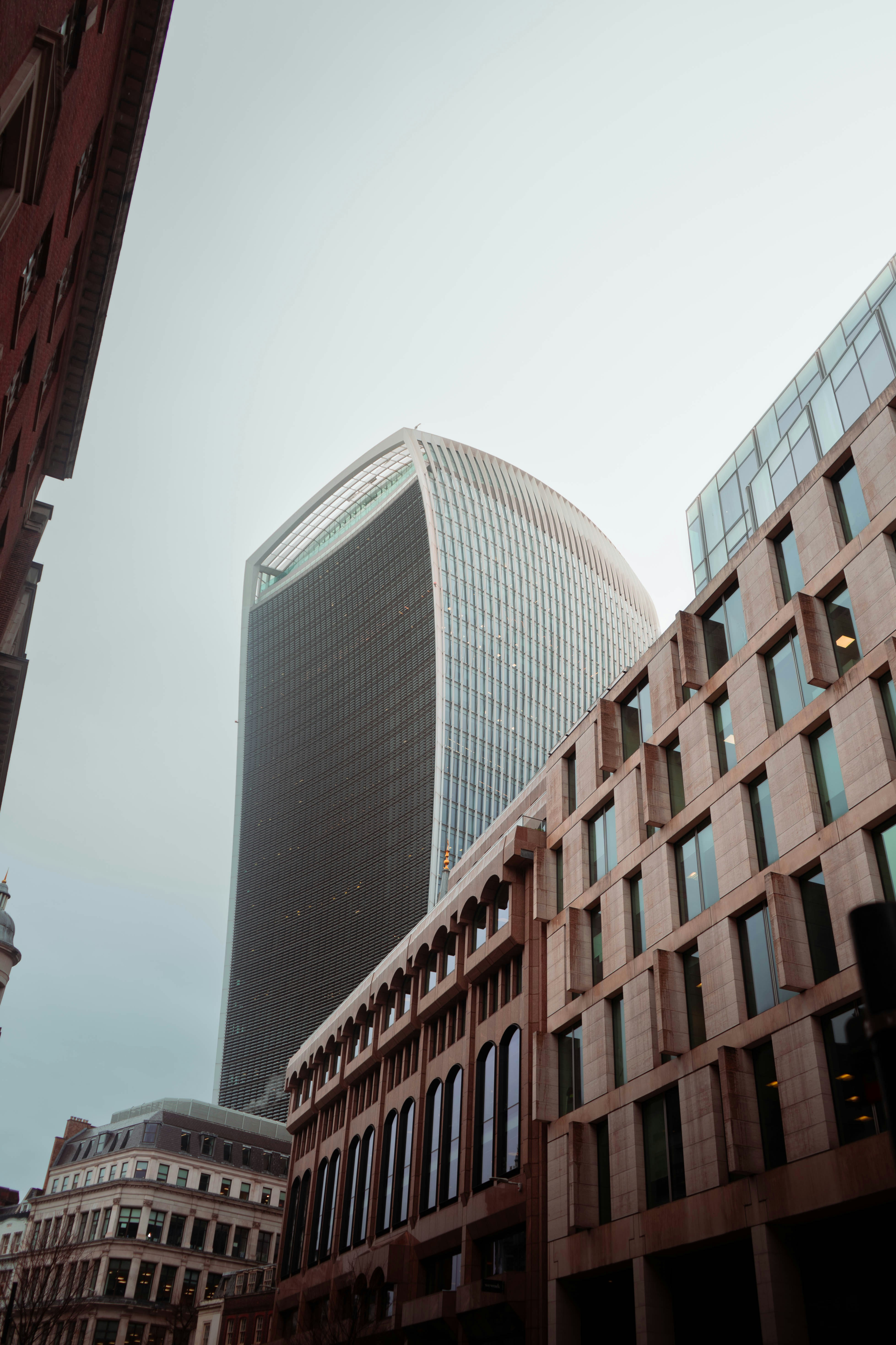A very tall building sitting next to other tall buildings photo – Free ...