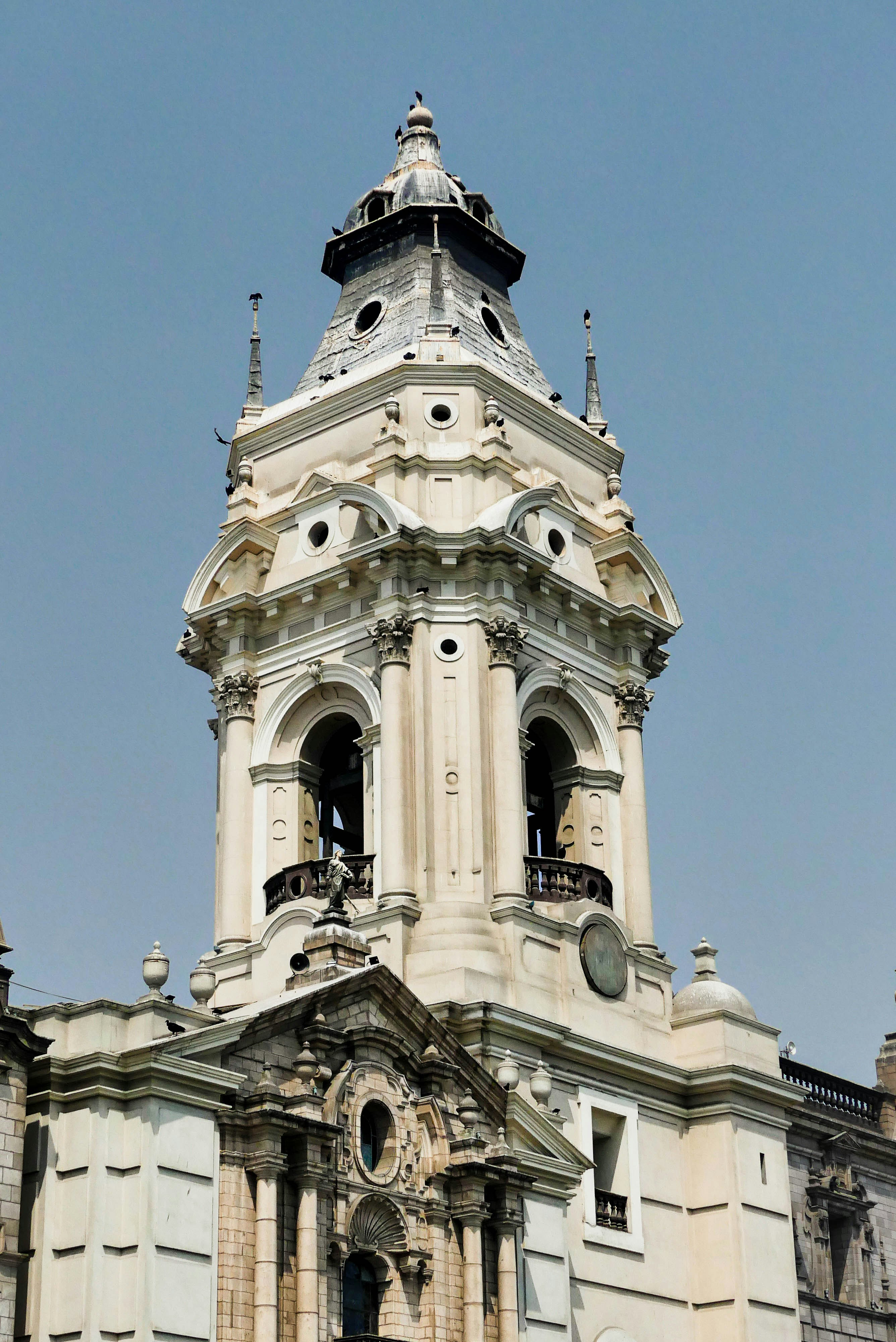 A tall building with a clock on the top of it photo – Free Lima Image ...