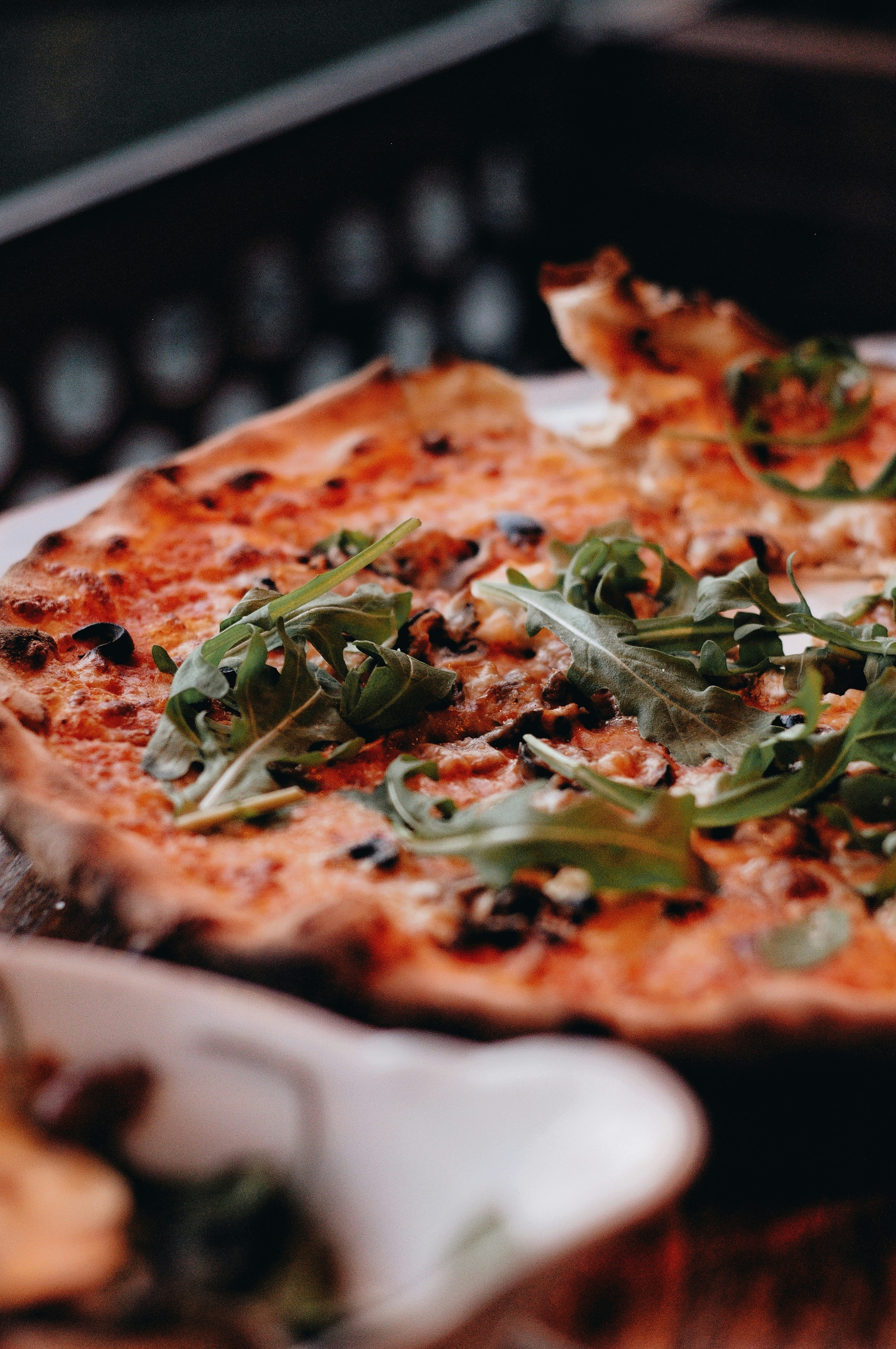 A close up of a pizza on a plate on a table photo – Free Food Image on ...