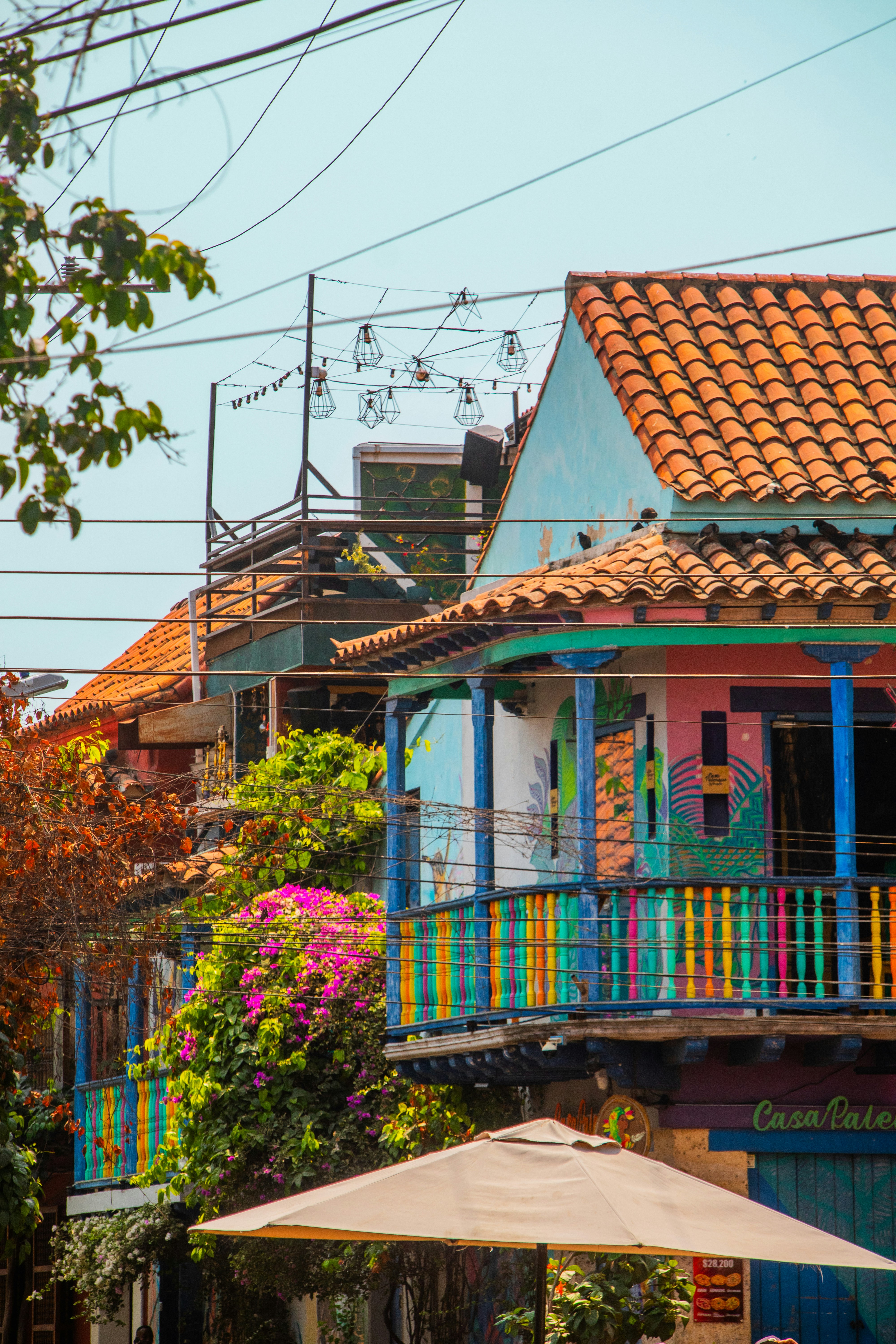 Sunlit Calle: A Tapestry of Balconies and Bougainvillea