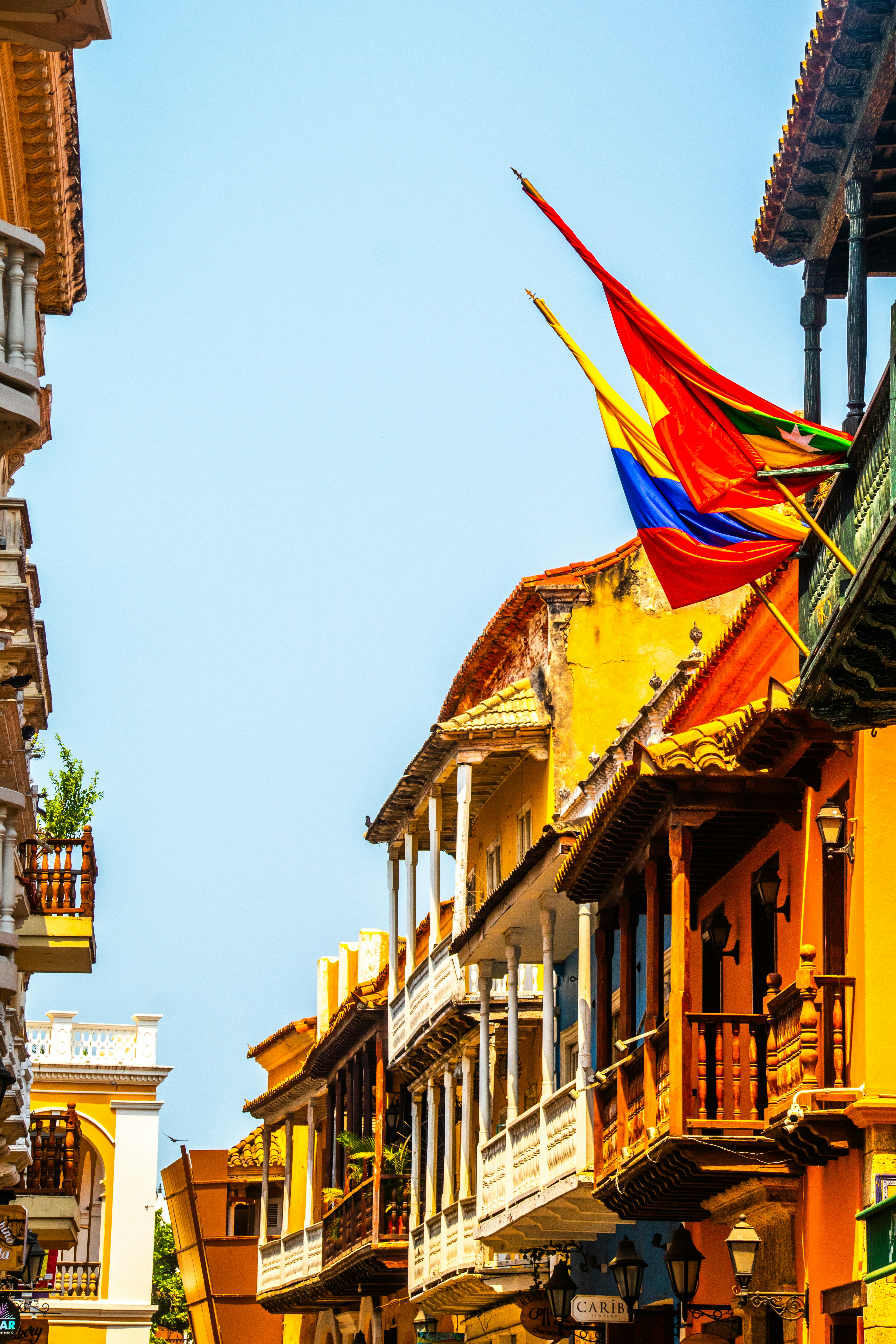Calle of Color: Flagged rooftops crown a sunlit colonial street