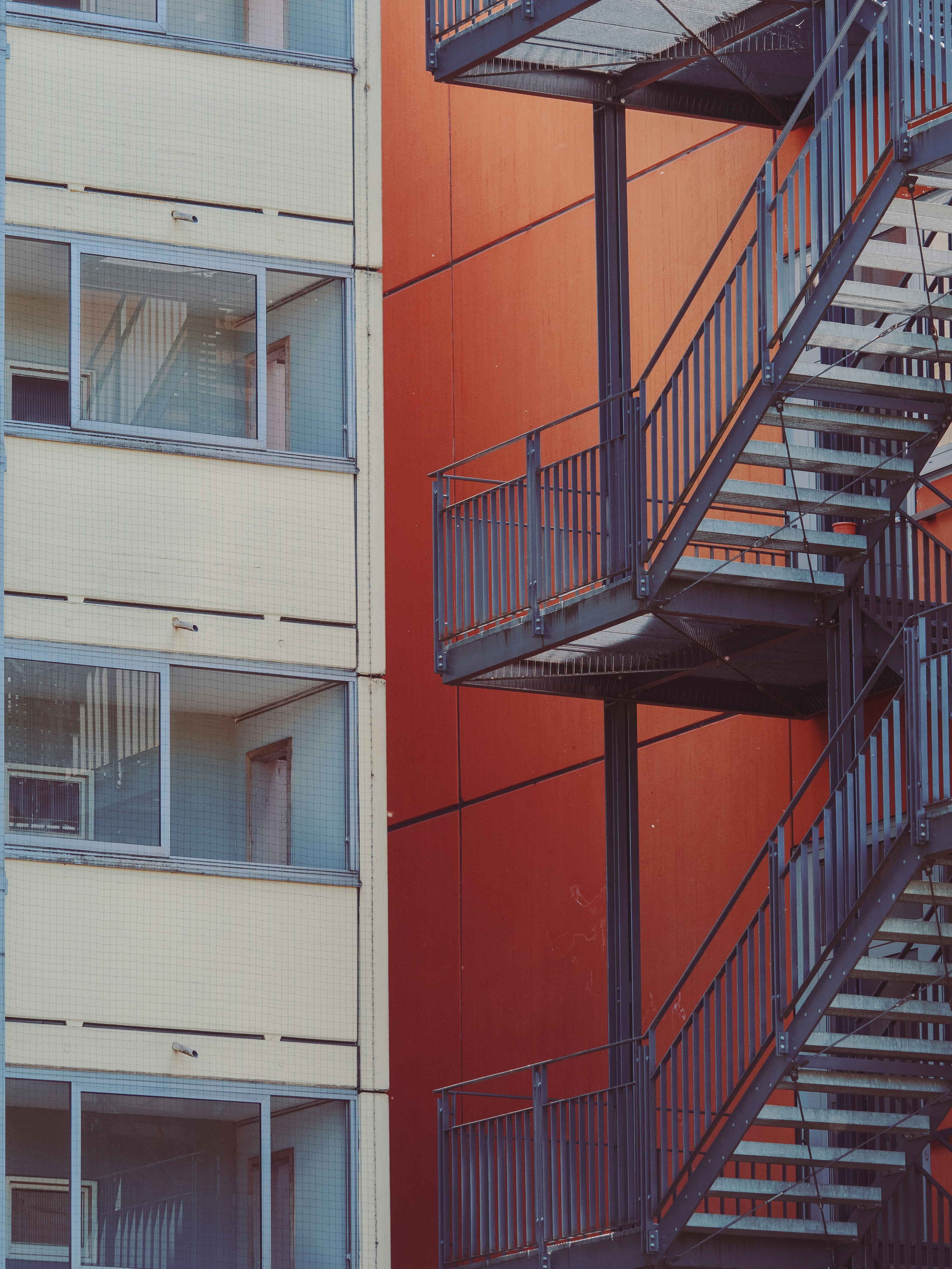 A fire escape next to a tall building photo – Free Building Image on ...