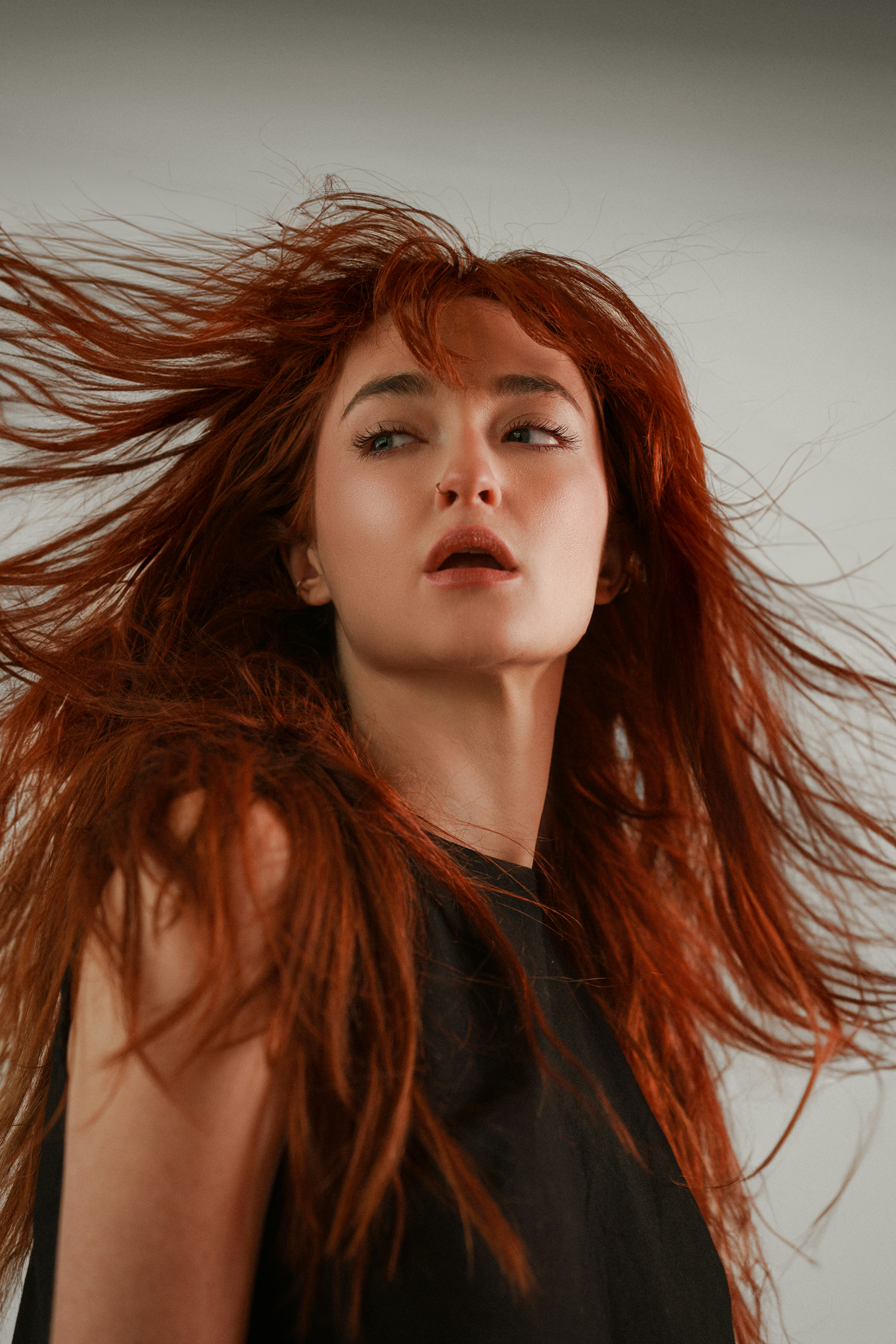A woman with red hair blowing in the wind photo – Free Portrait girl ...