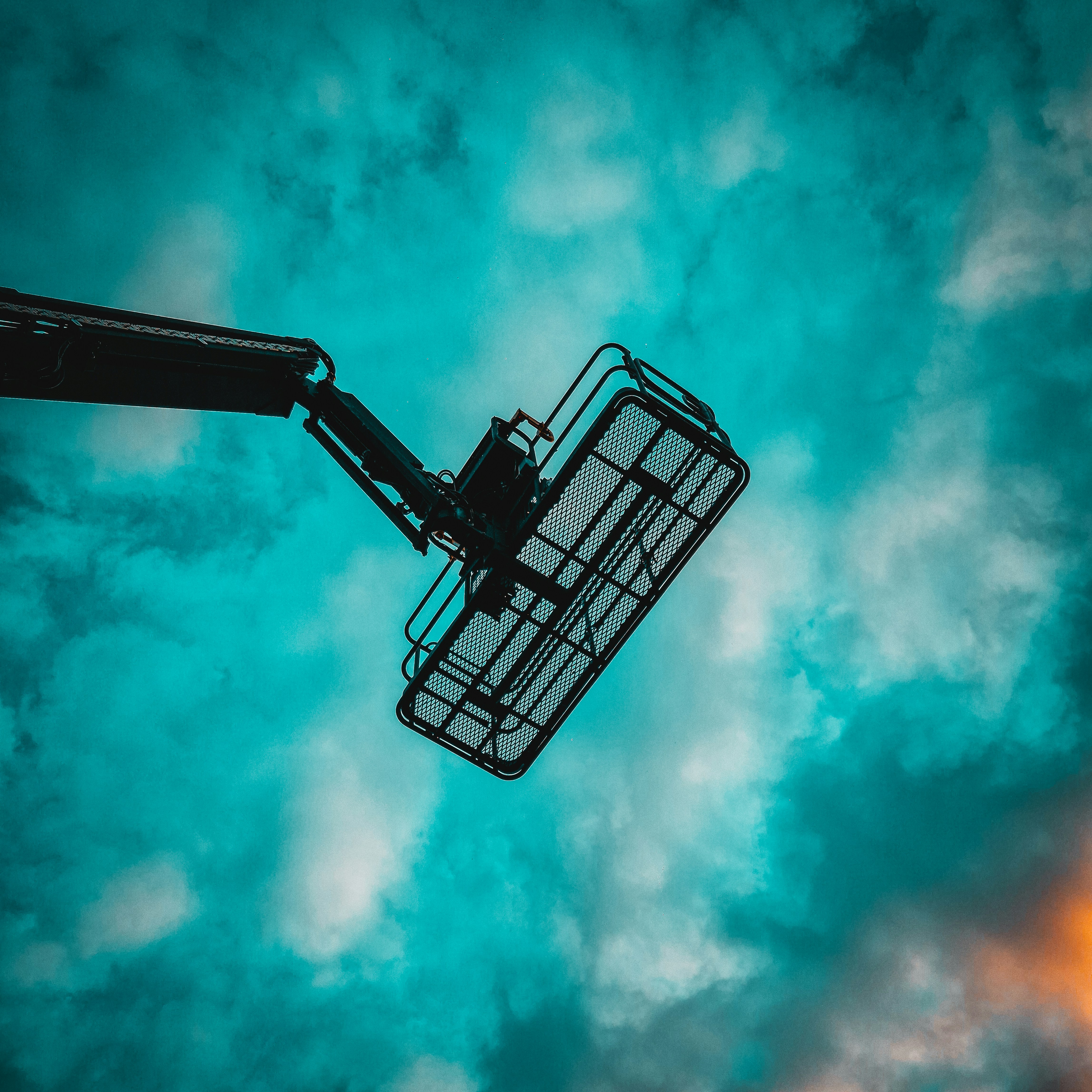 Teal Skies, Steel Silhouette: The Aerial Work Basket