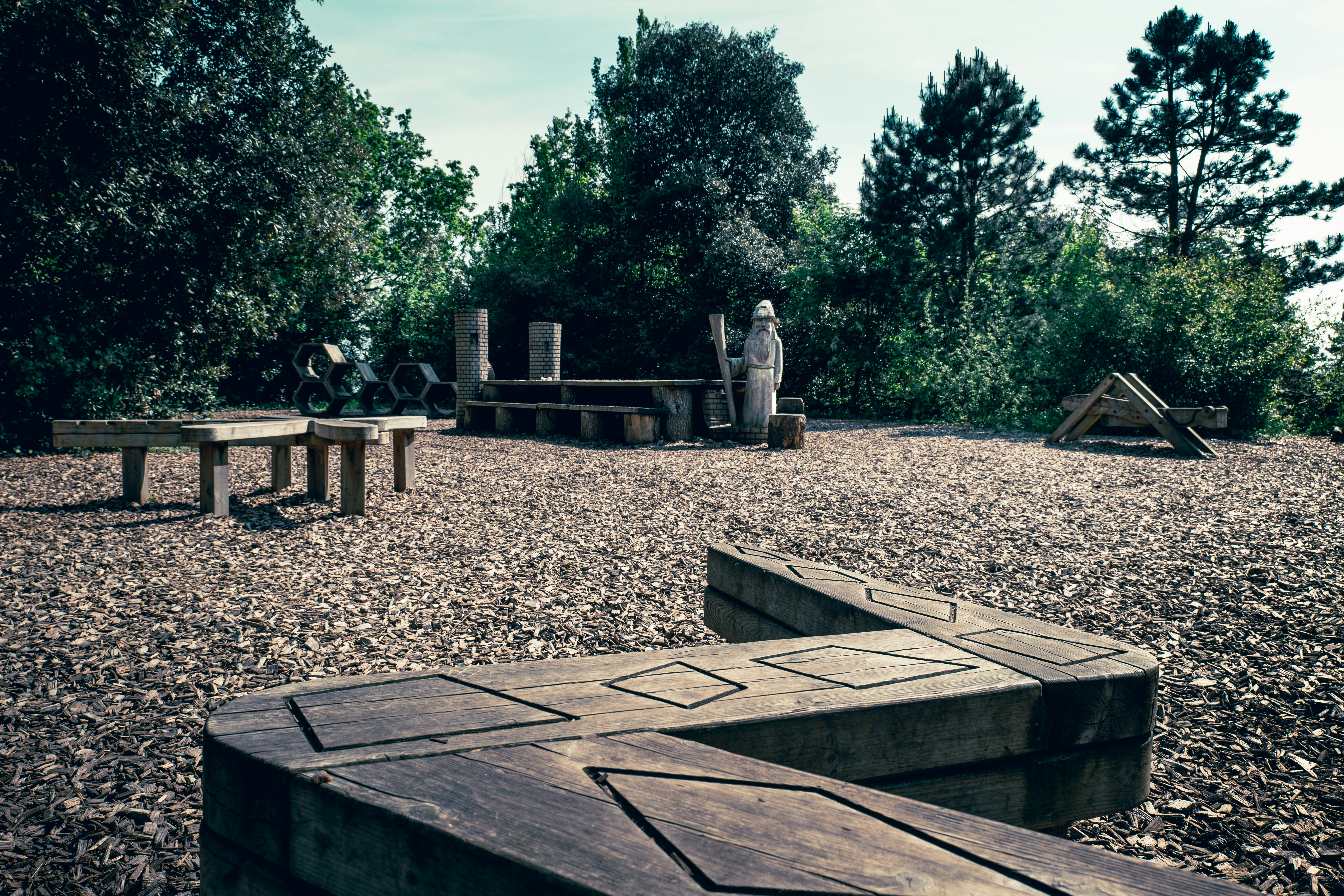 Geometry in a Quiet Park: Concrete Blocks Framing a Tree-Lined Horizon