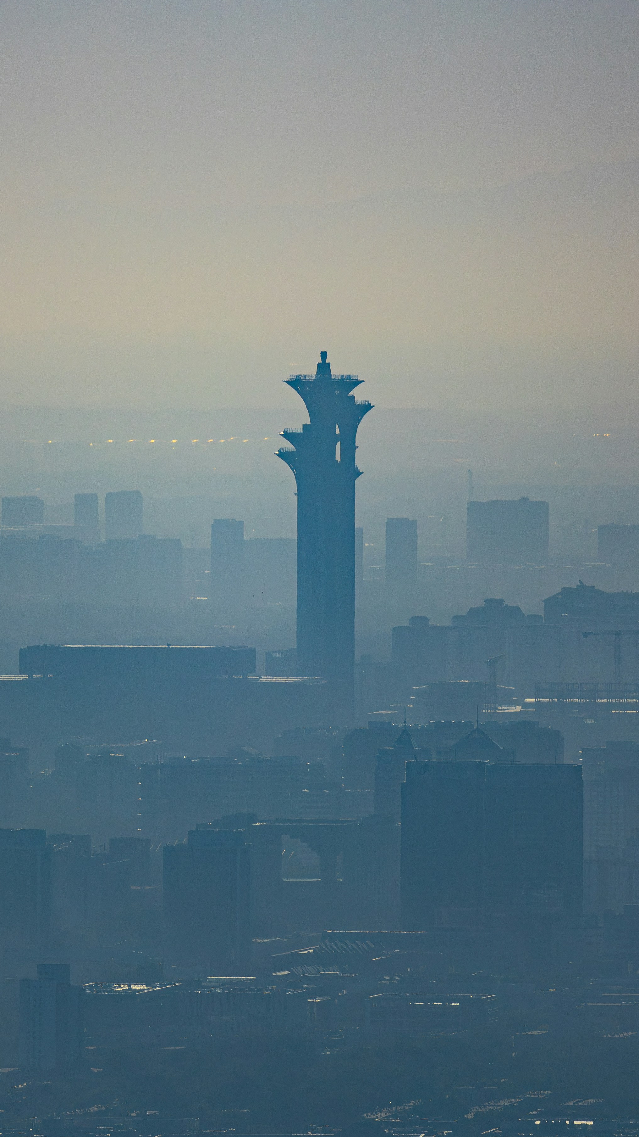 Misty spire rising over a quiet cityscape