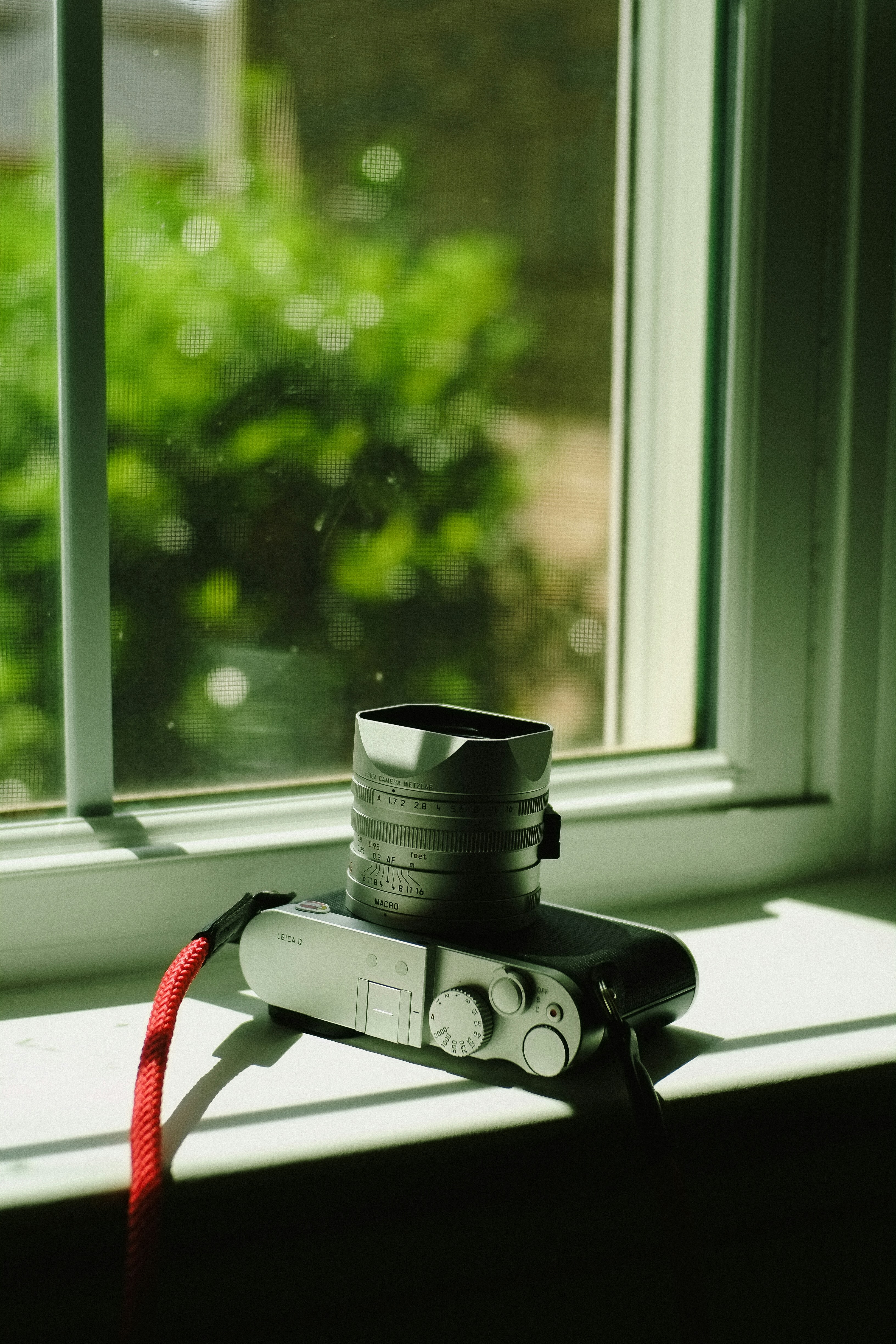 A camera sitting on top of a window sill photo – Free Green Image on ...