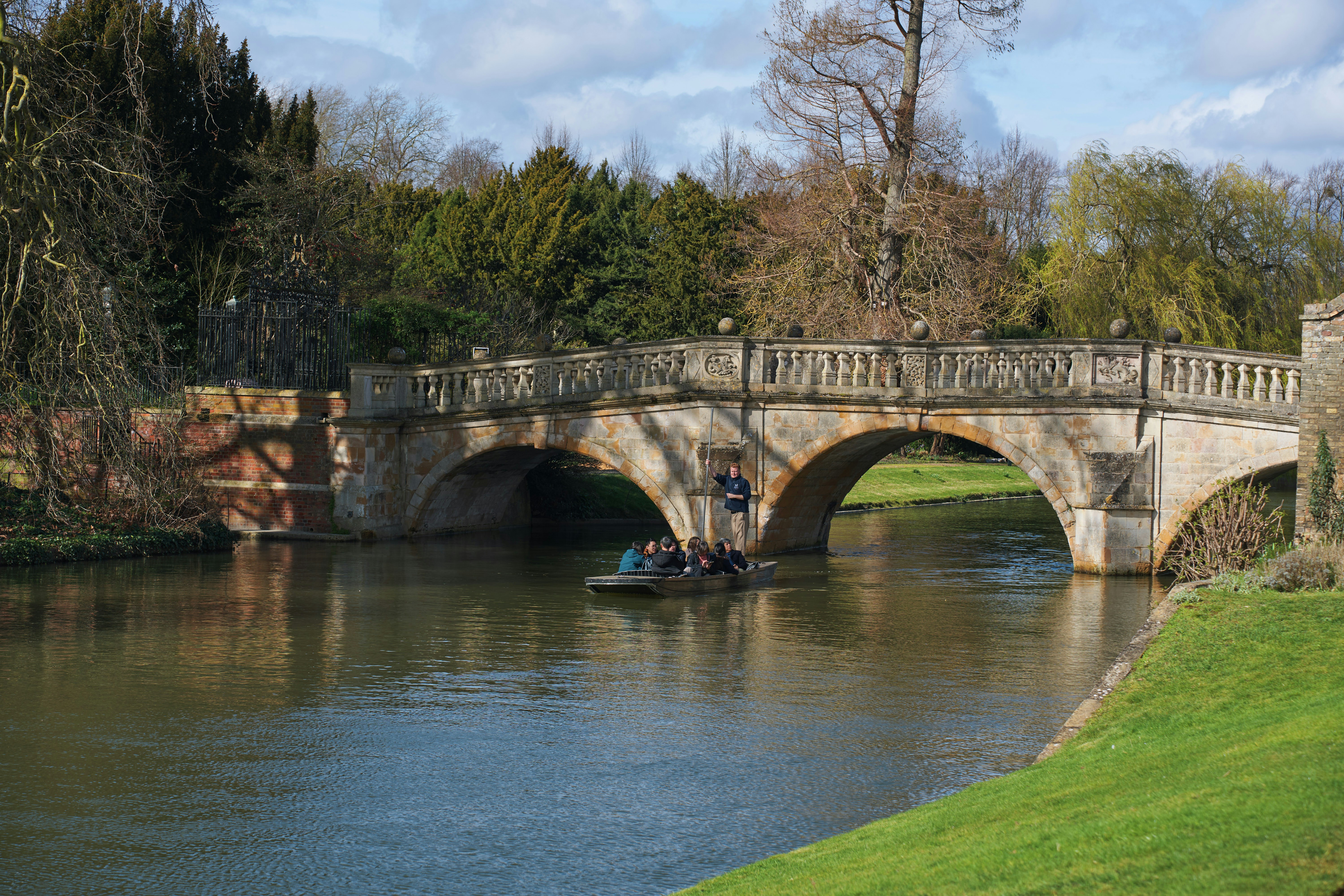 A bridge over a body of water with a boat on it photo – Free Central ...