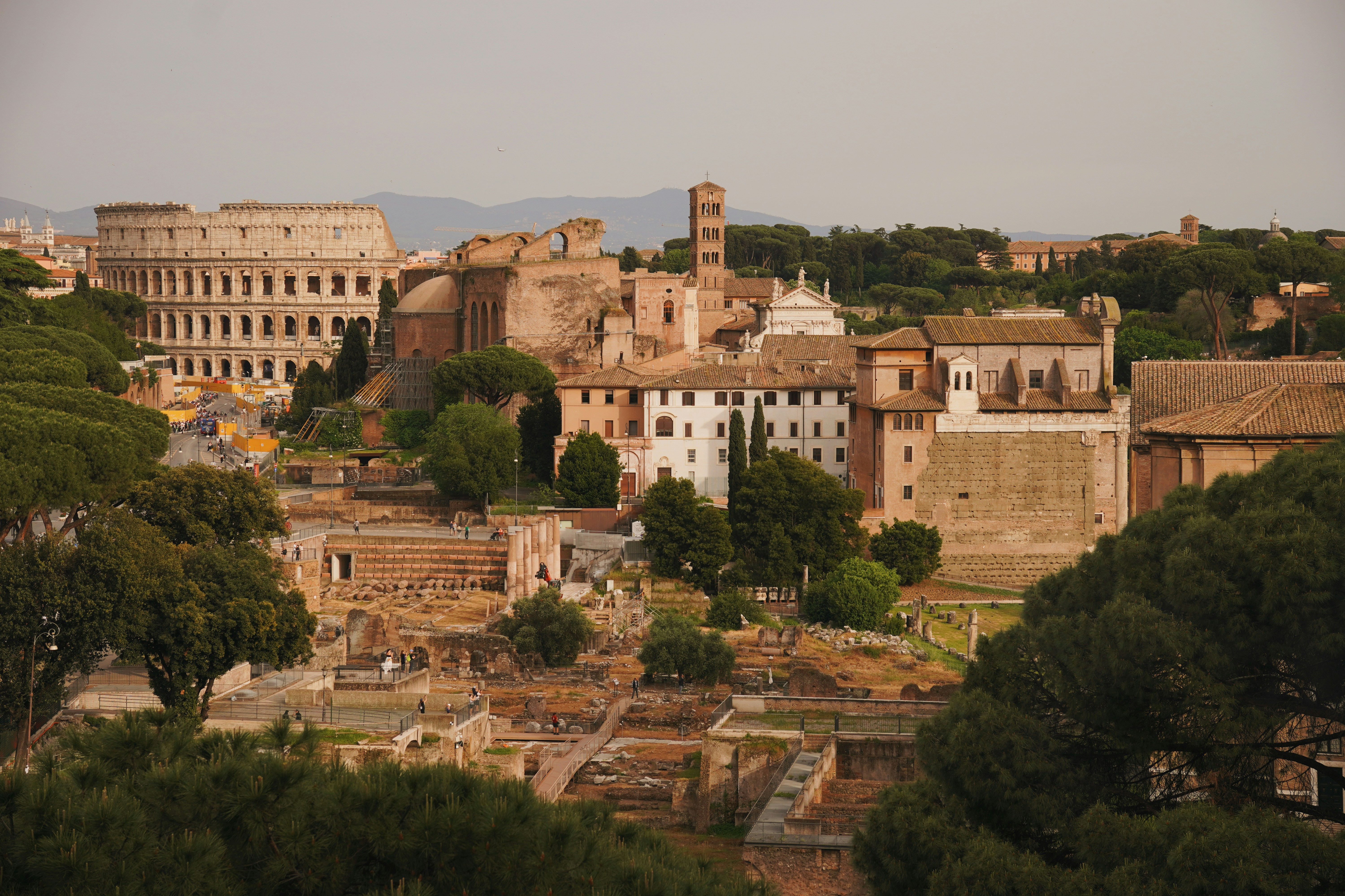The panoramic view on ancient Rome city with Coliseum and Roman Forum