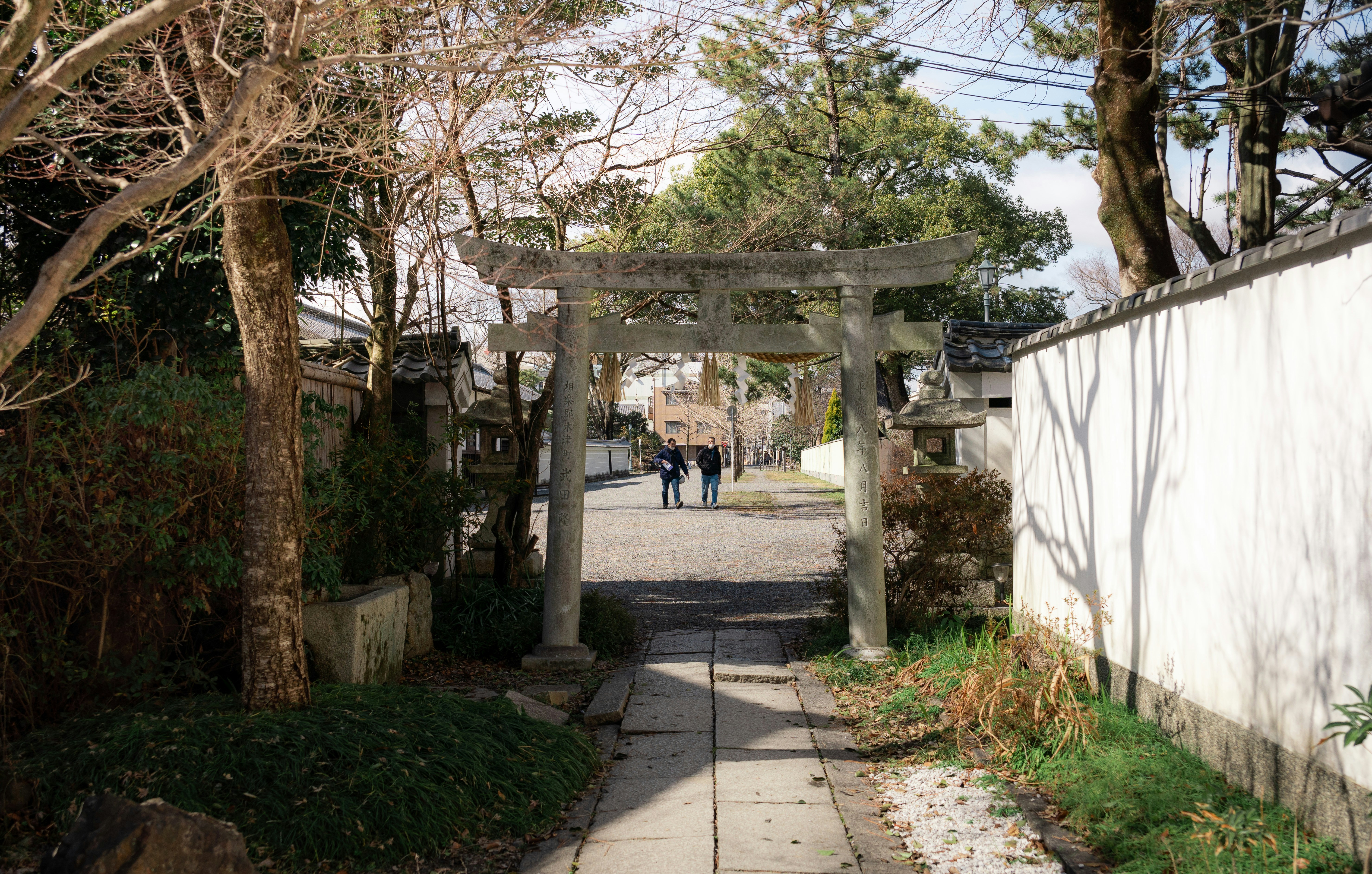 Torii Gate Framing a Sunlit Path Toward a Quiet Shrine