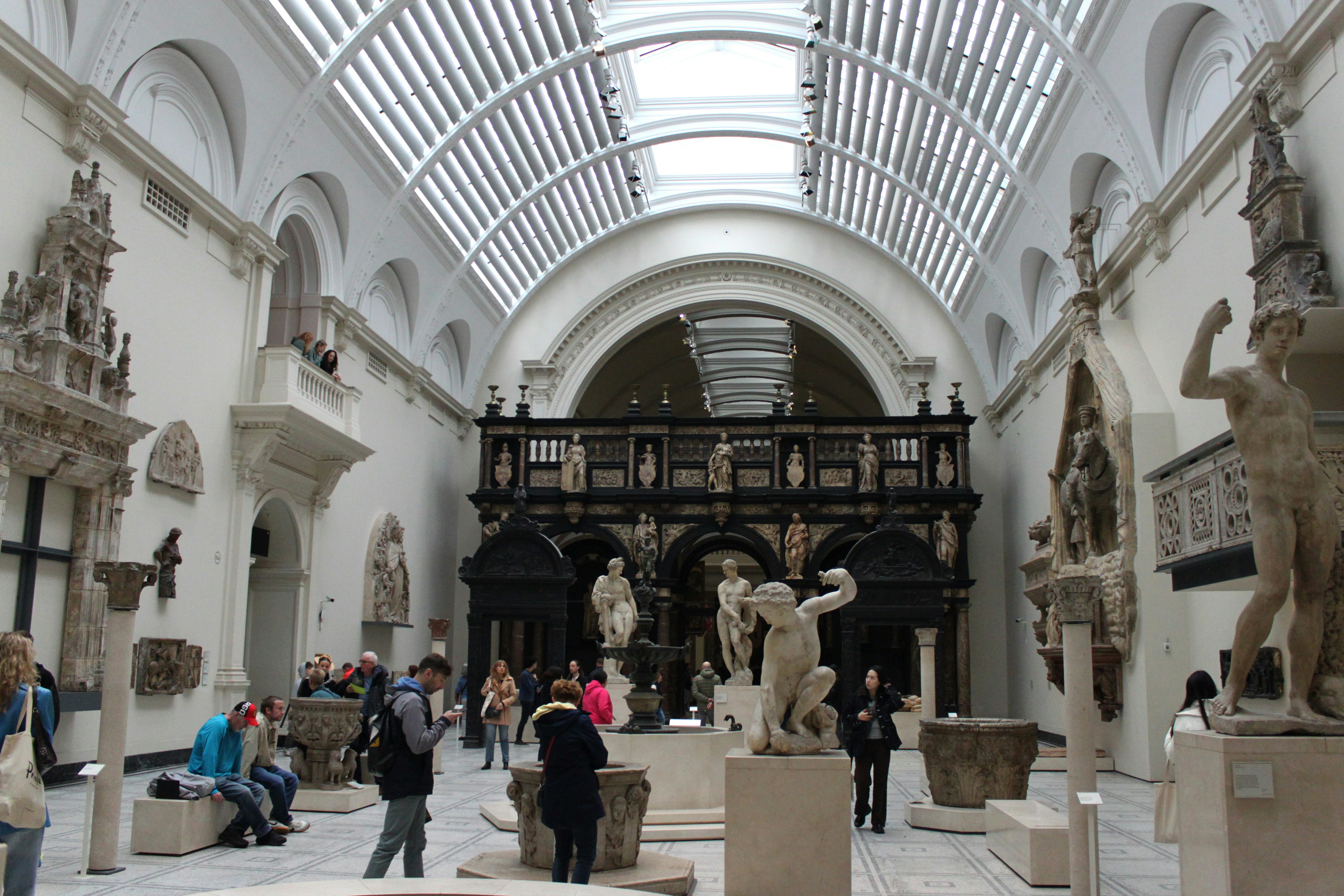 A group of people looking at statues in a museum photo – Free Black ...