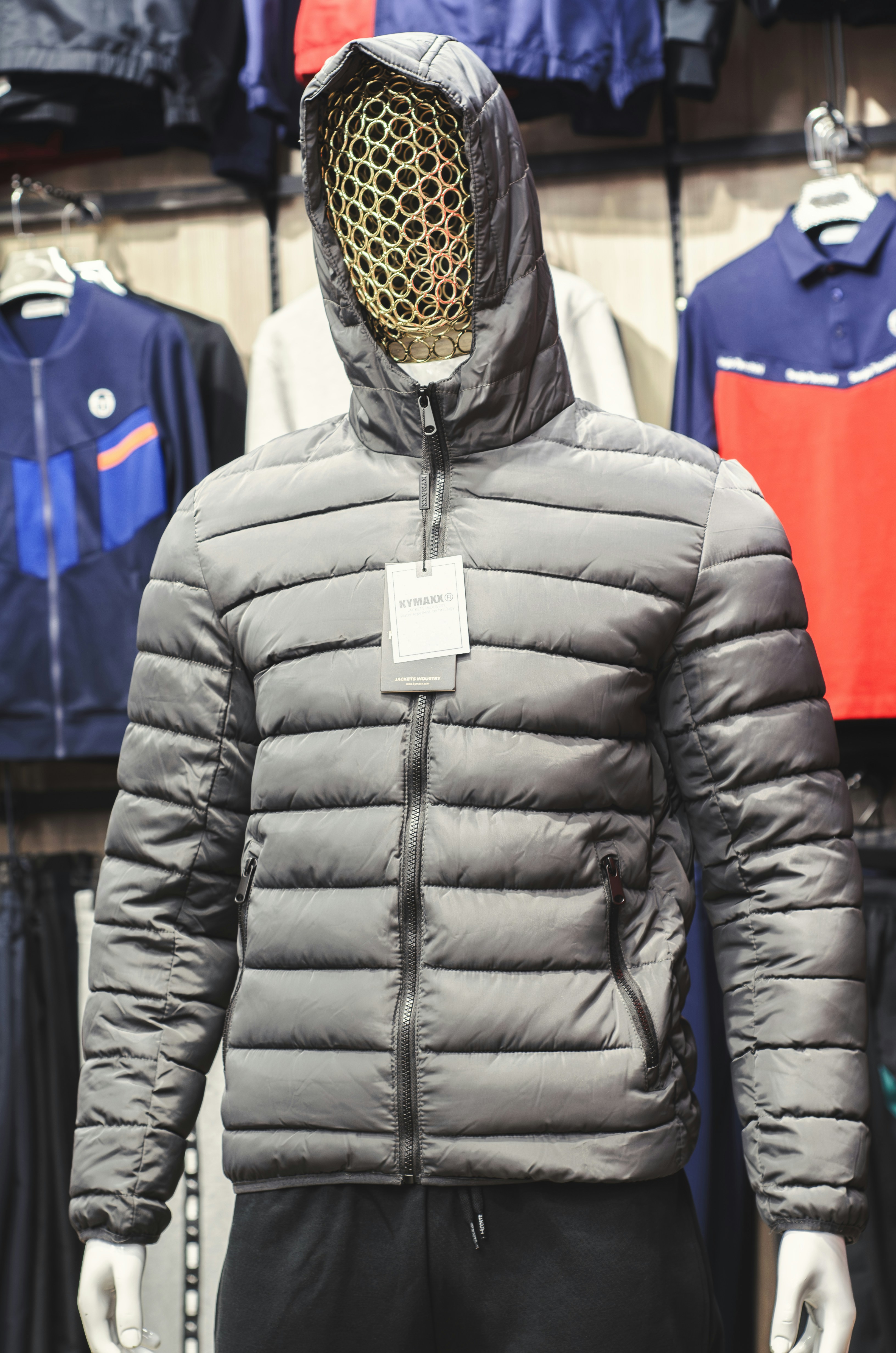 Masked Puffer on Display: A Monolithic Jacket in a Quiet Shop