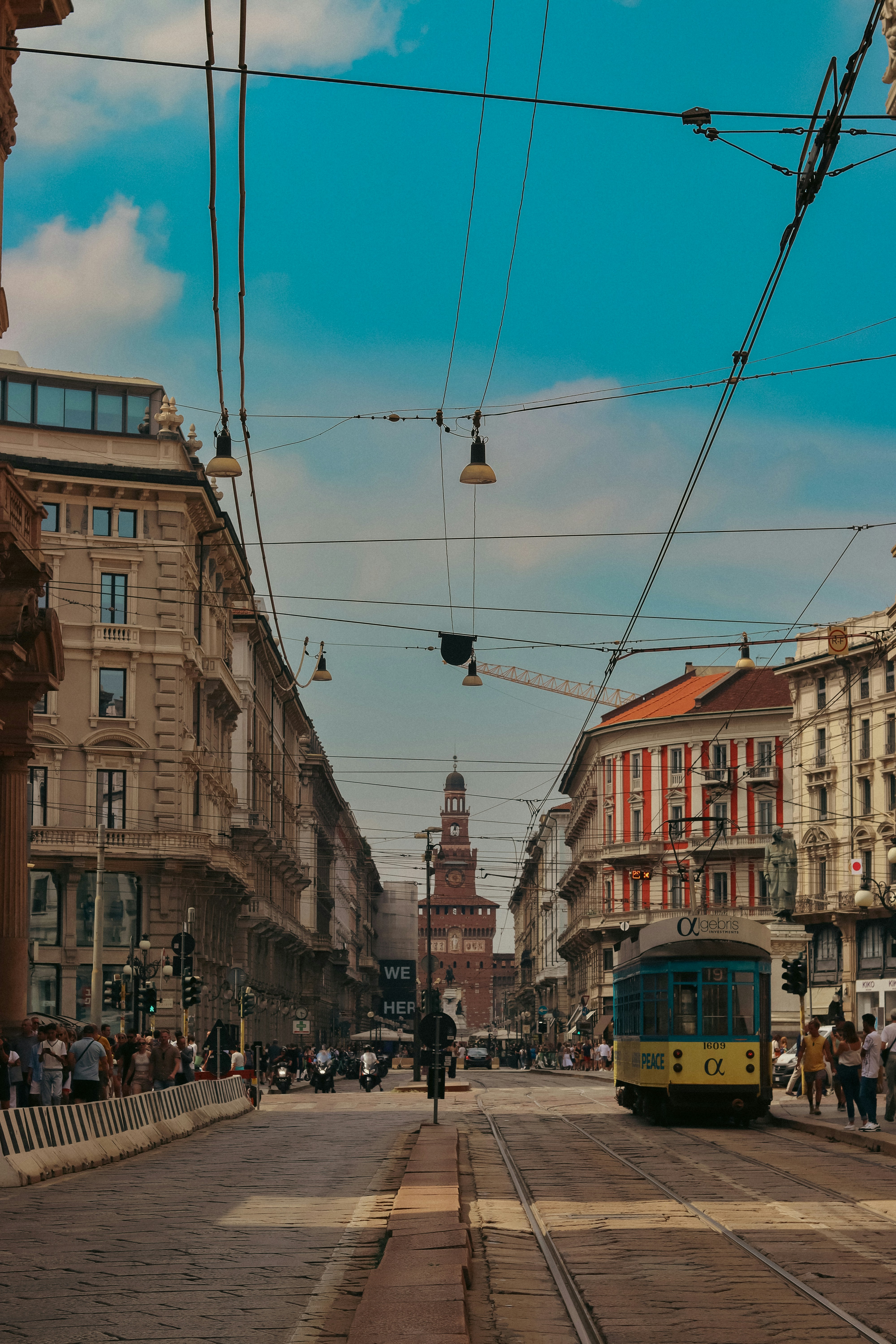 Toward the Clock Tower: Converging Tram Tracks in a Sunlit European Street