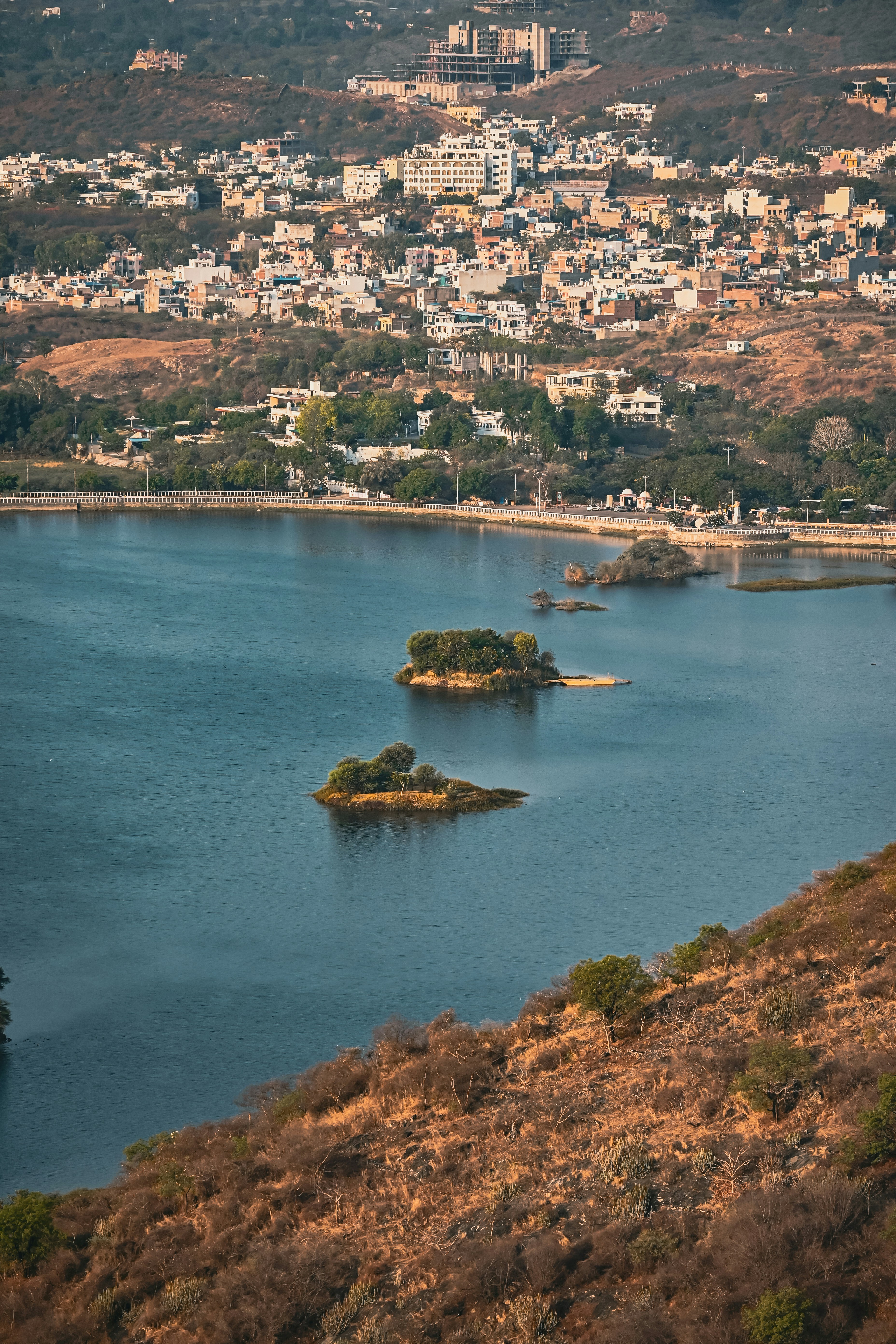 Verdant Islets Mark the Quiet Bay Before a Terraced Hillside City