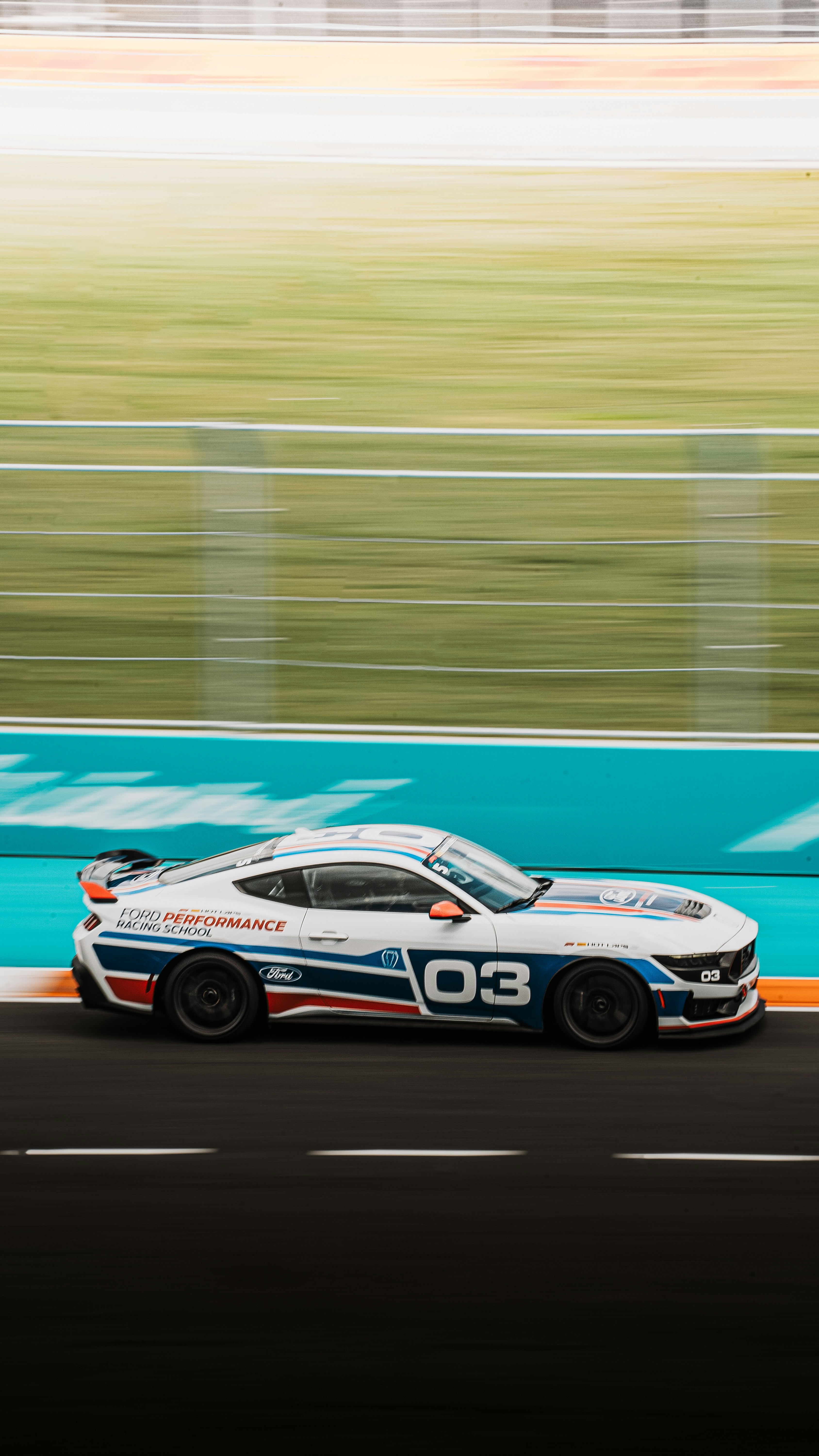 Number 03: A White Race Car Slashing Through Motion Blur on the Circuit