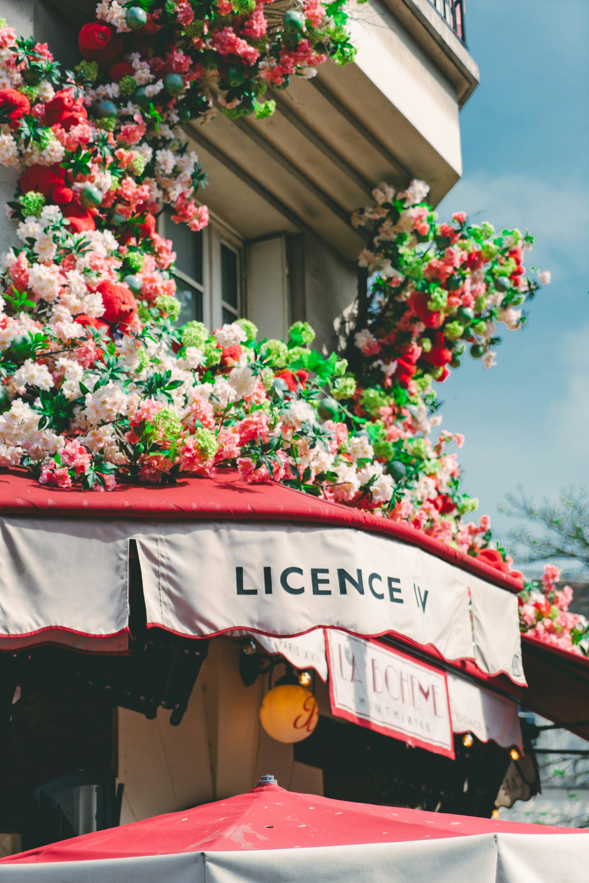Floral Balcony over a Parisian Café Awning