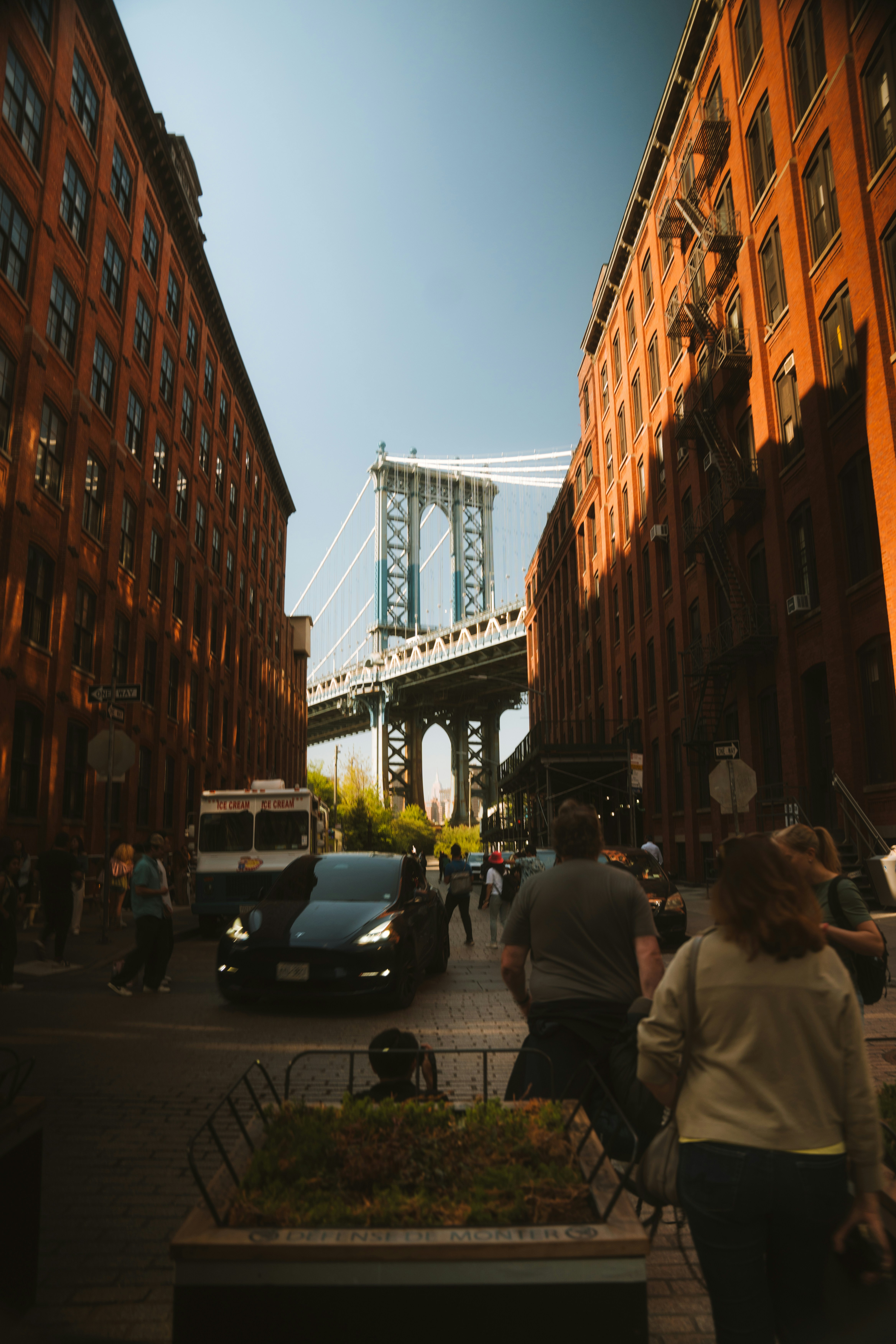 Toward the Bridge: City Canyon Between Brick Towers