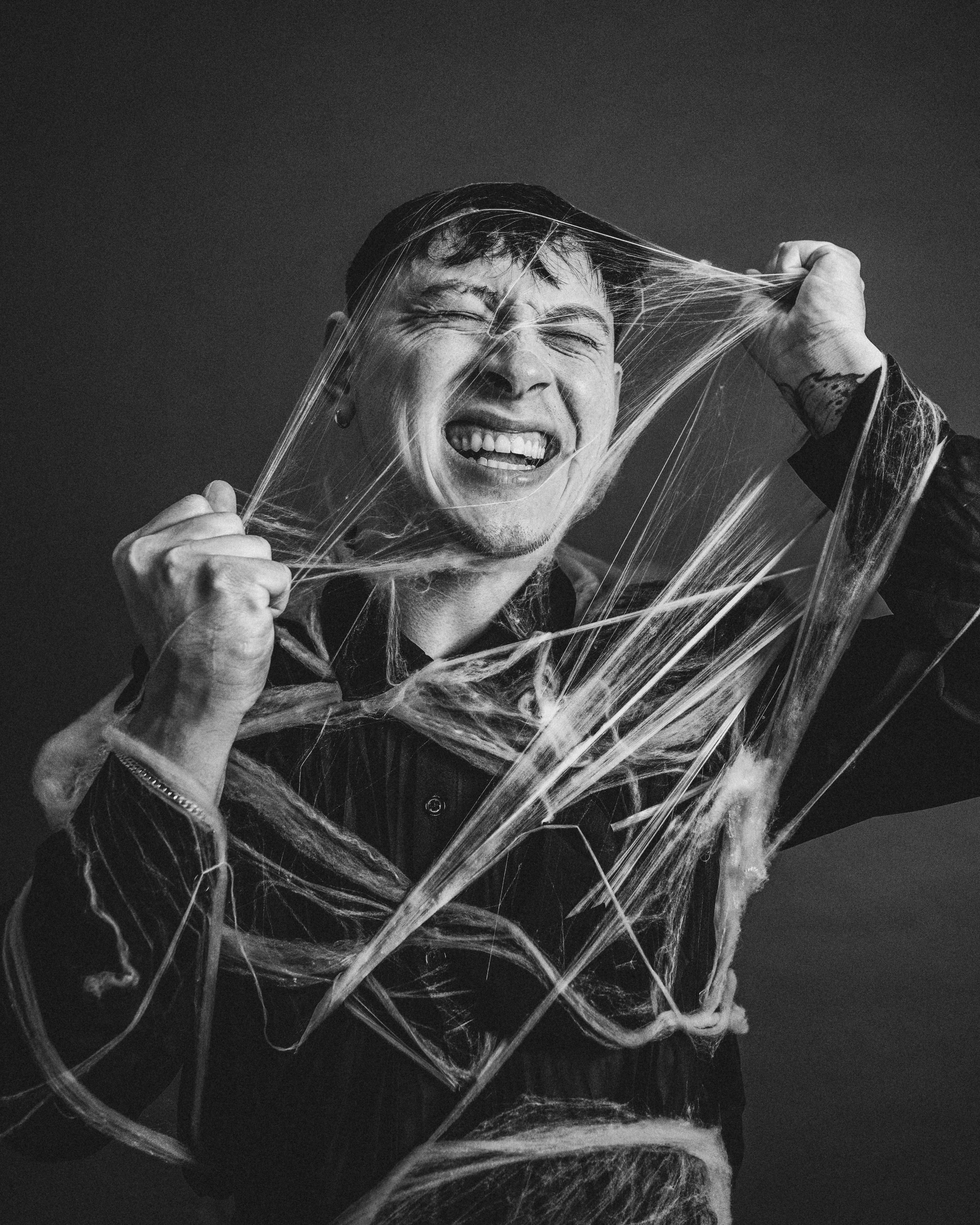 A man holding a string wrapped around his face photo – Free Grey Image ...